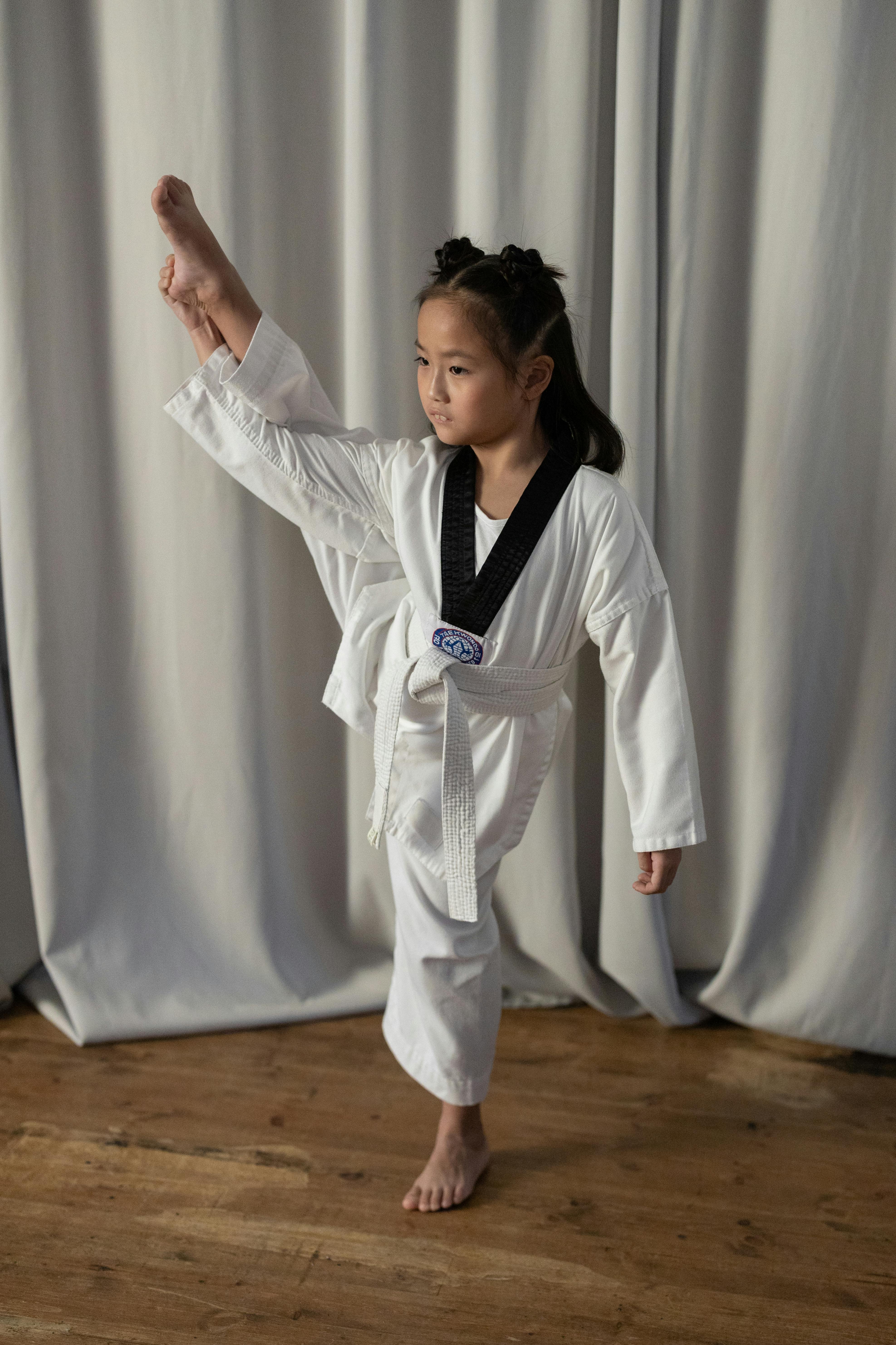 A Girl Wearing Dobok Stretching Her Leg · Free Stock Photo