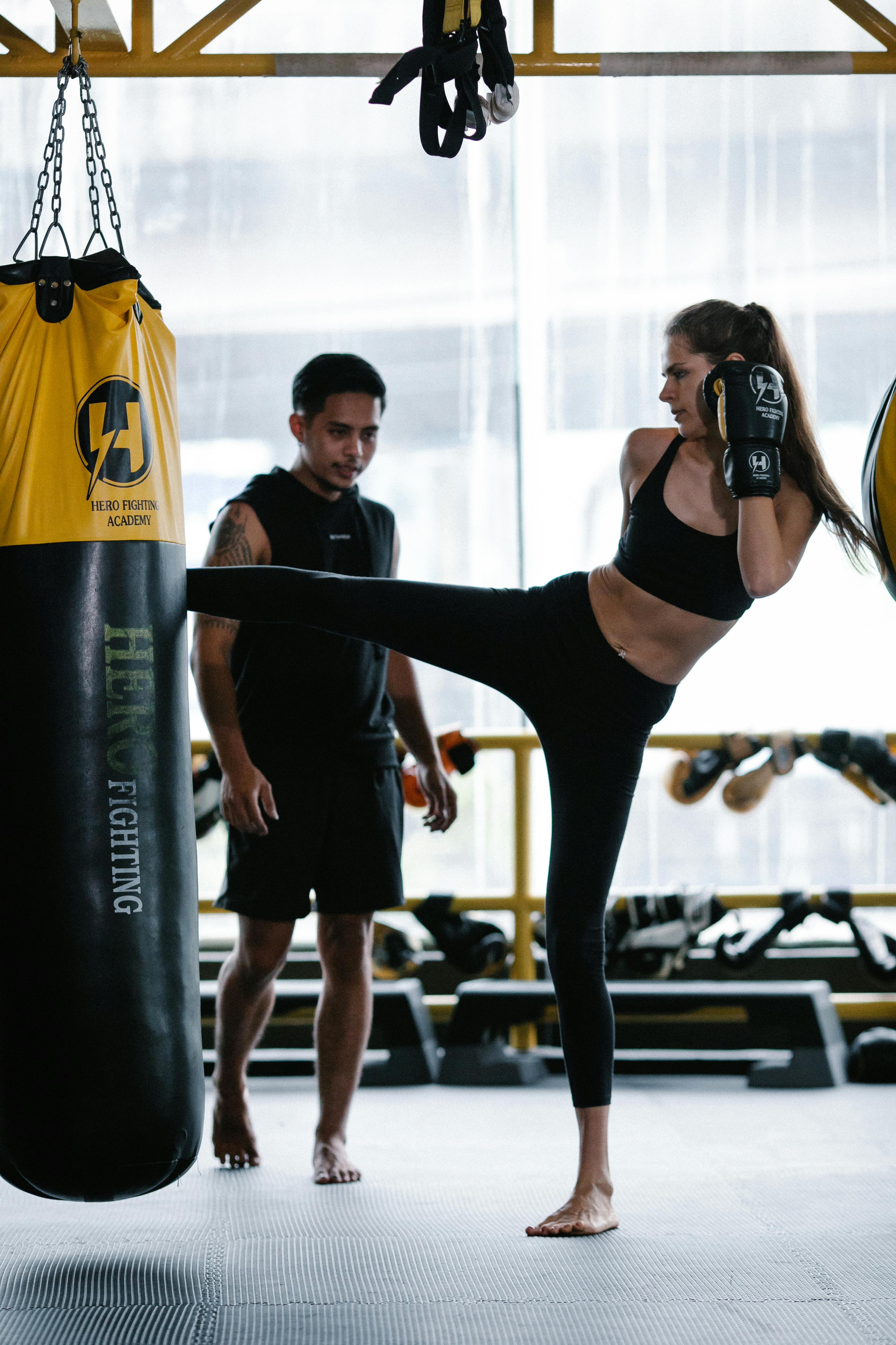 Woman Kicking the Heavy Bag · Free Stock Photo