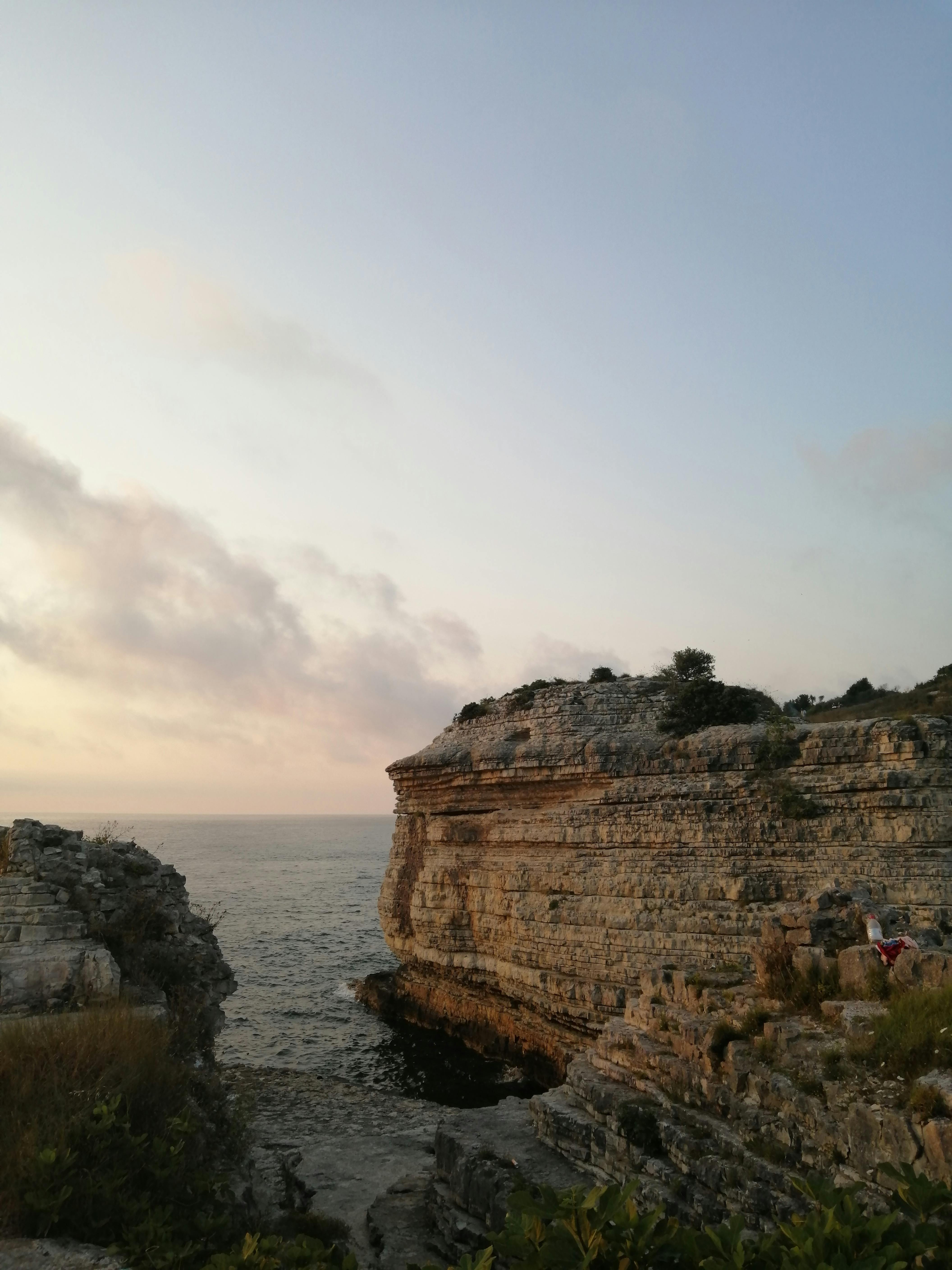 Brown Rocky Mountain near Ocean · Free Stock Photo
