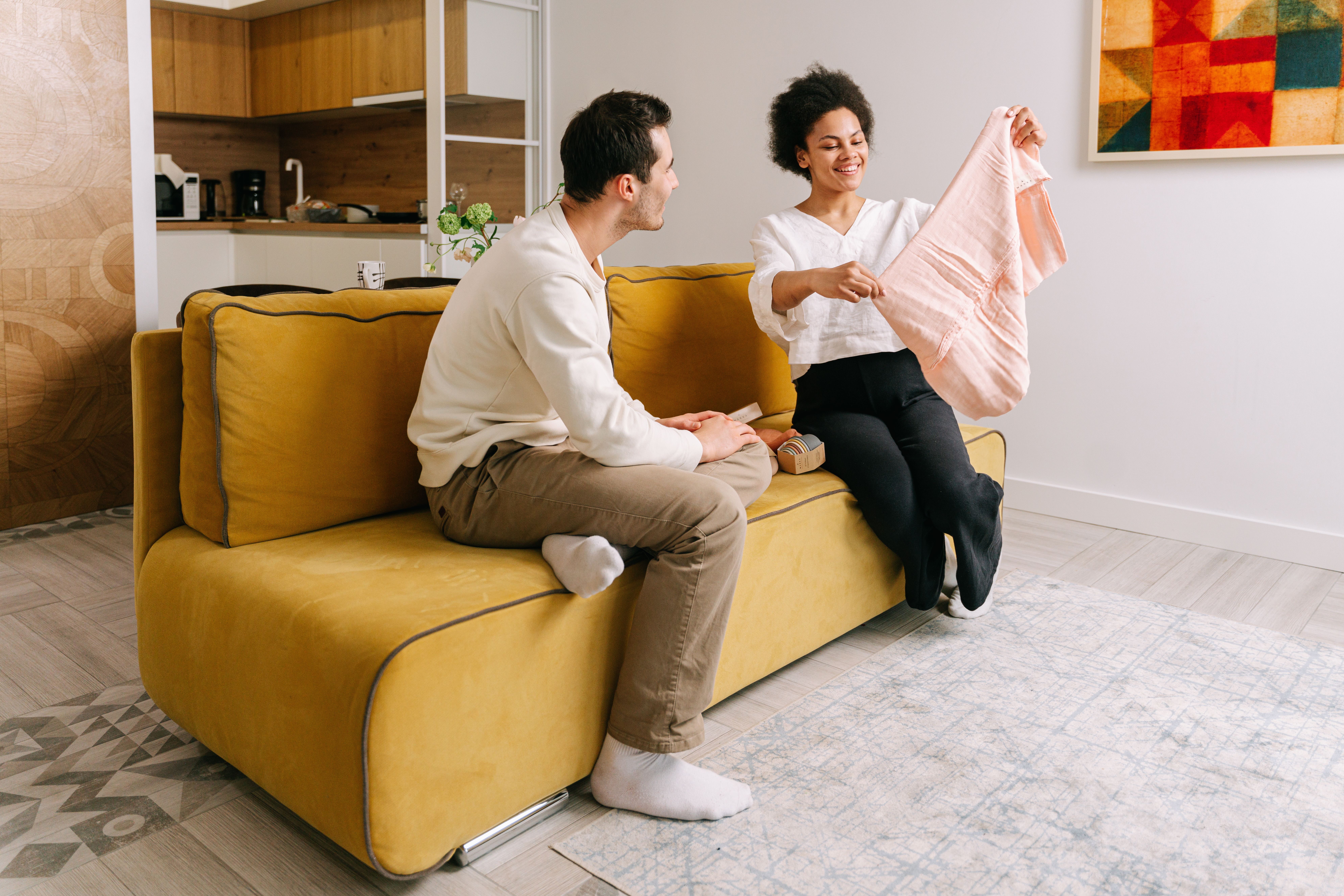 A Couple Sitting on the Couch while Having Conversation · Free Stock Photo