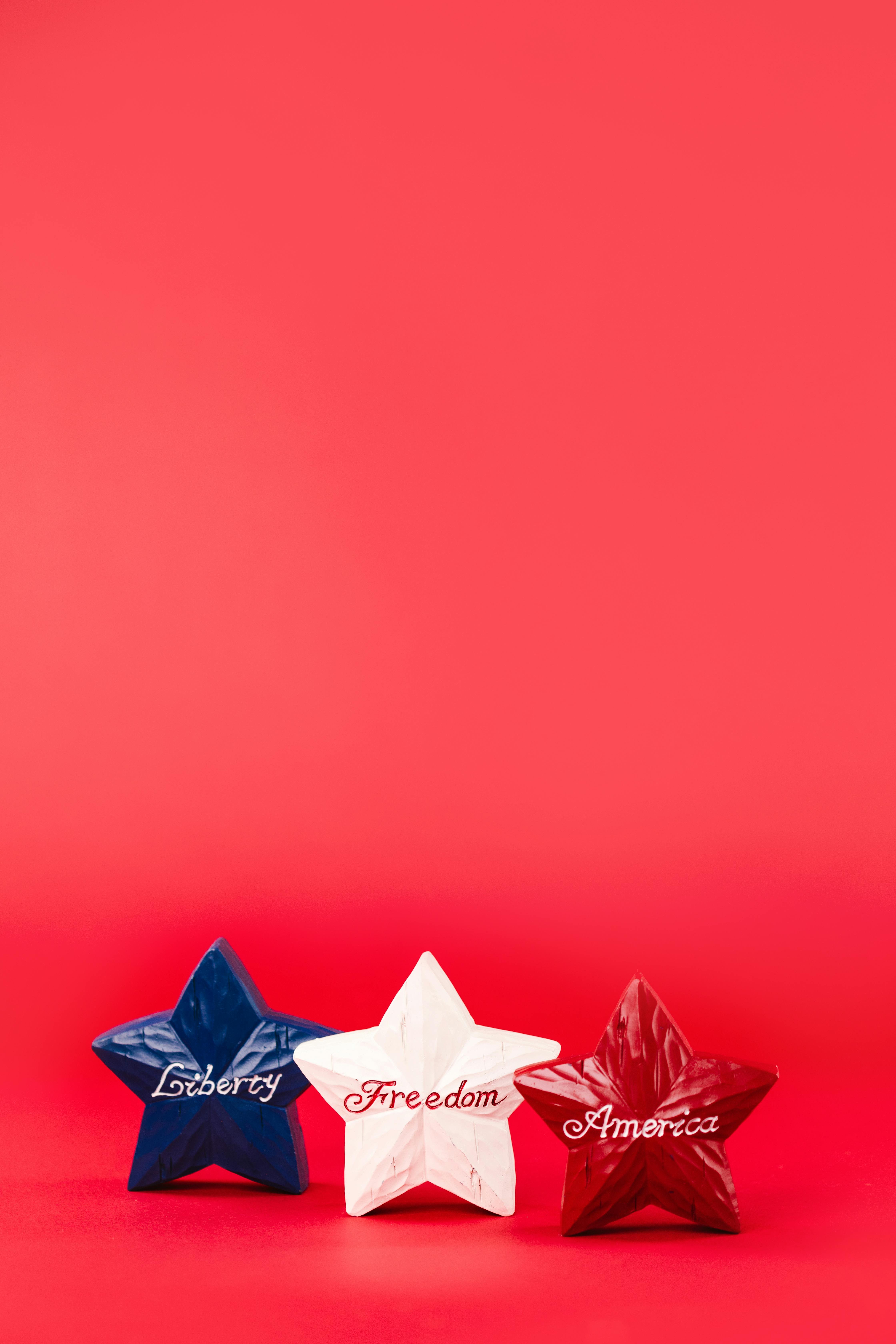 Star Shape Decorations on Red Background · Free Stock Photo