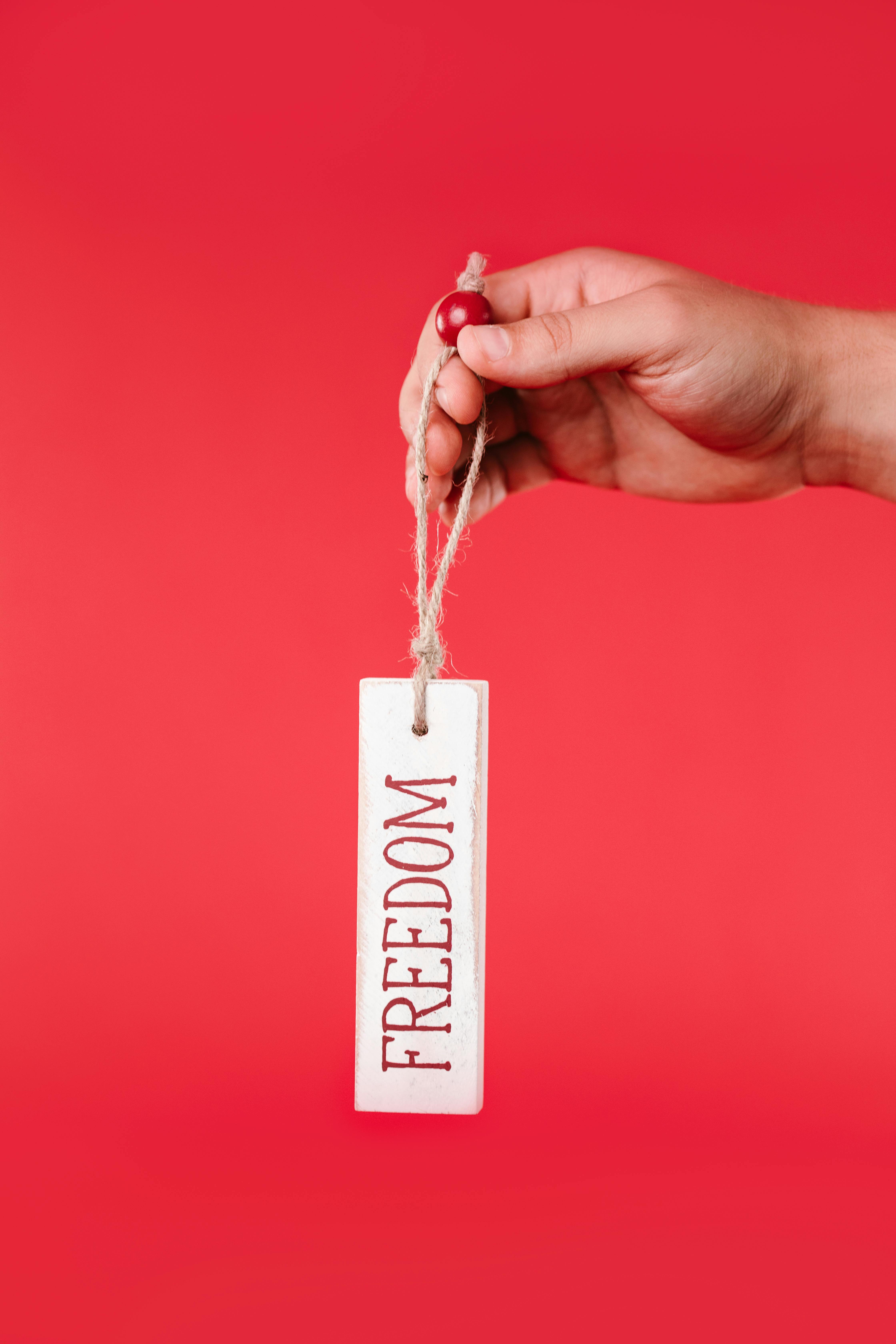 Person Holding a Hang Tag With Print · Free Stock Photo