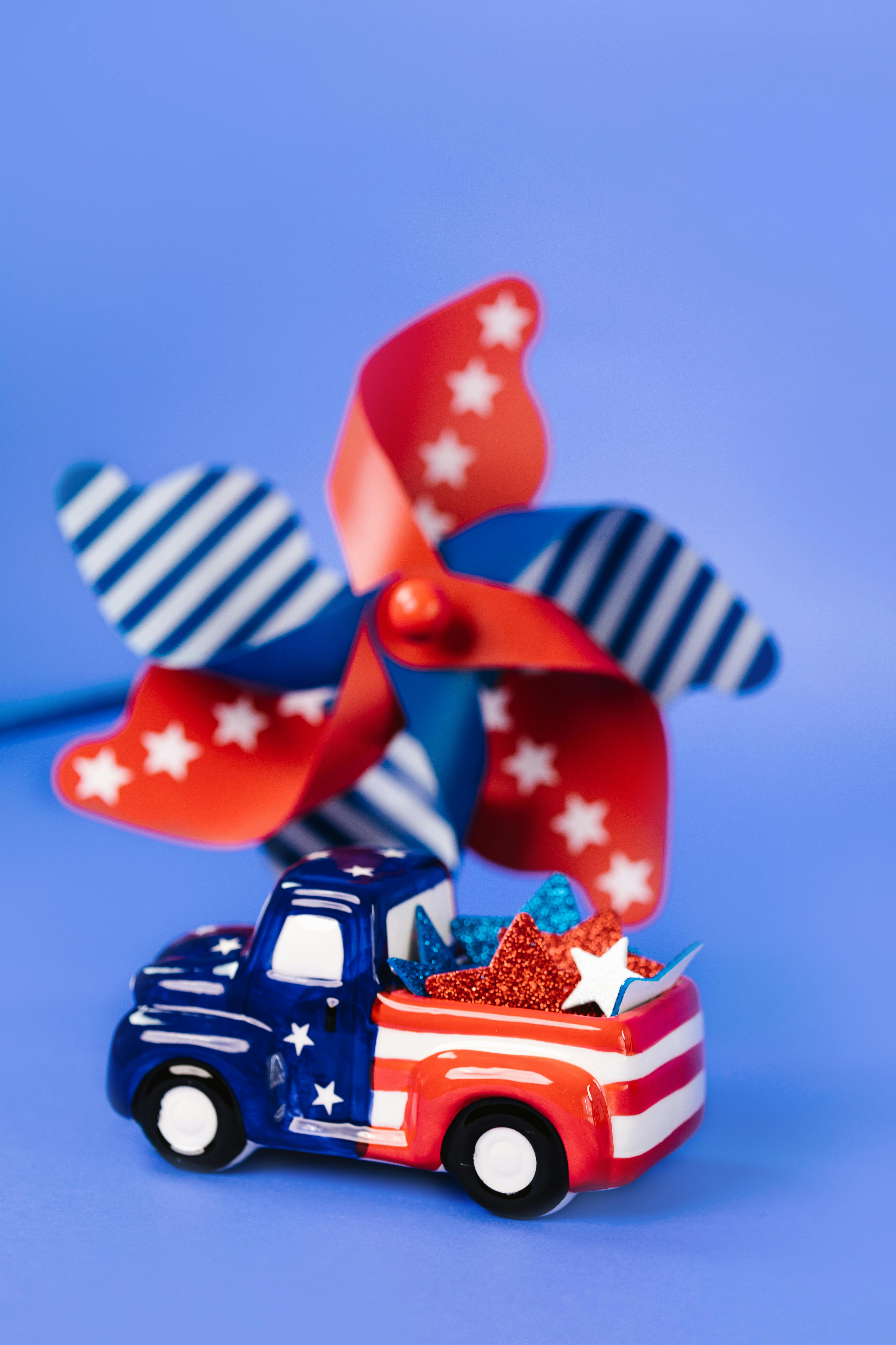 A Pinwheel and Toy Truck With Stars and Stripes Design · Free Stock Photo