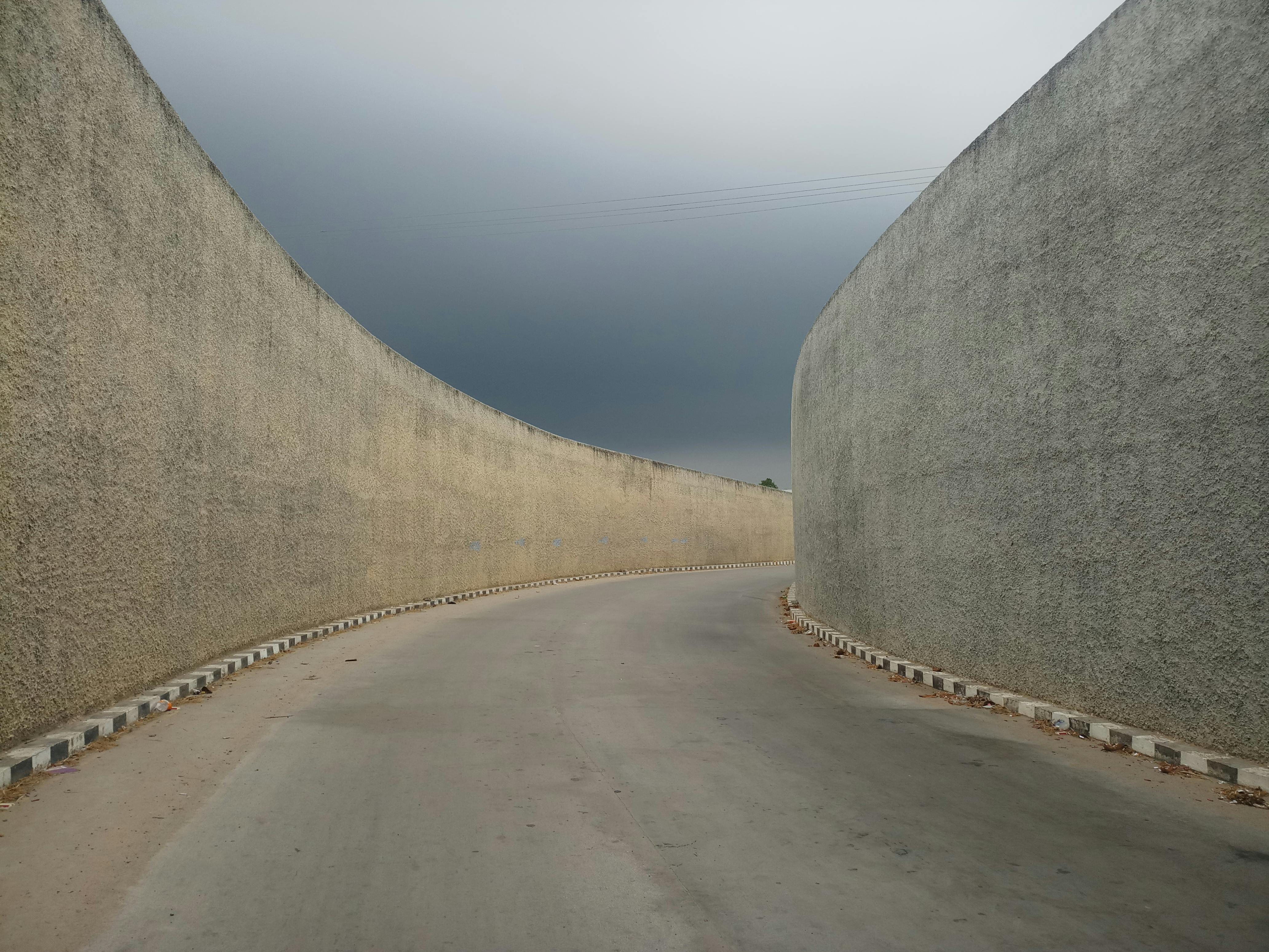 Gray Concrete Road Between Houses · Free Stock Photo