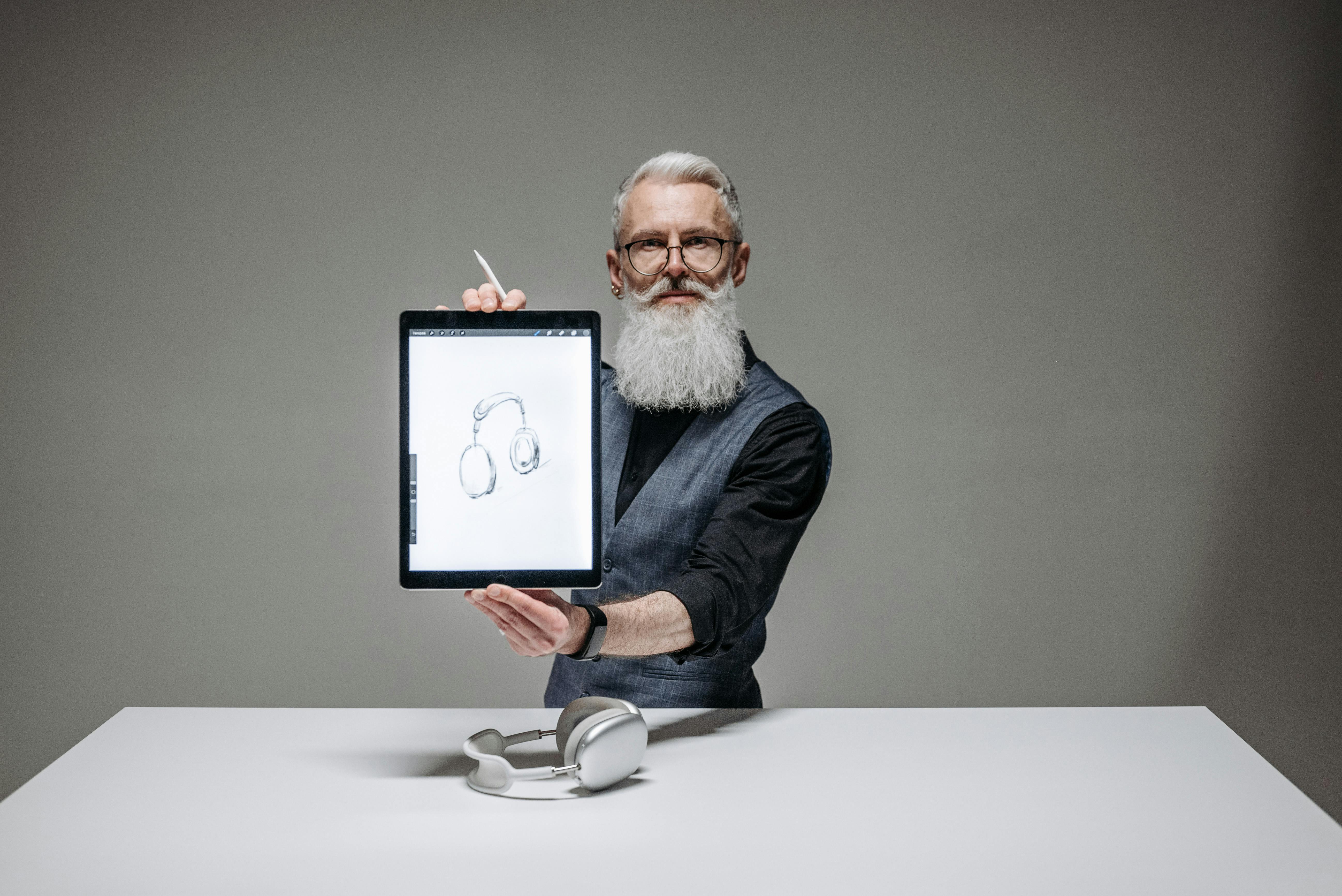 Man Holding a Picture on a Tablet · Free Stock Photo