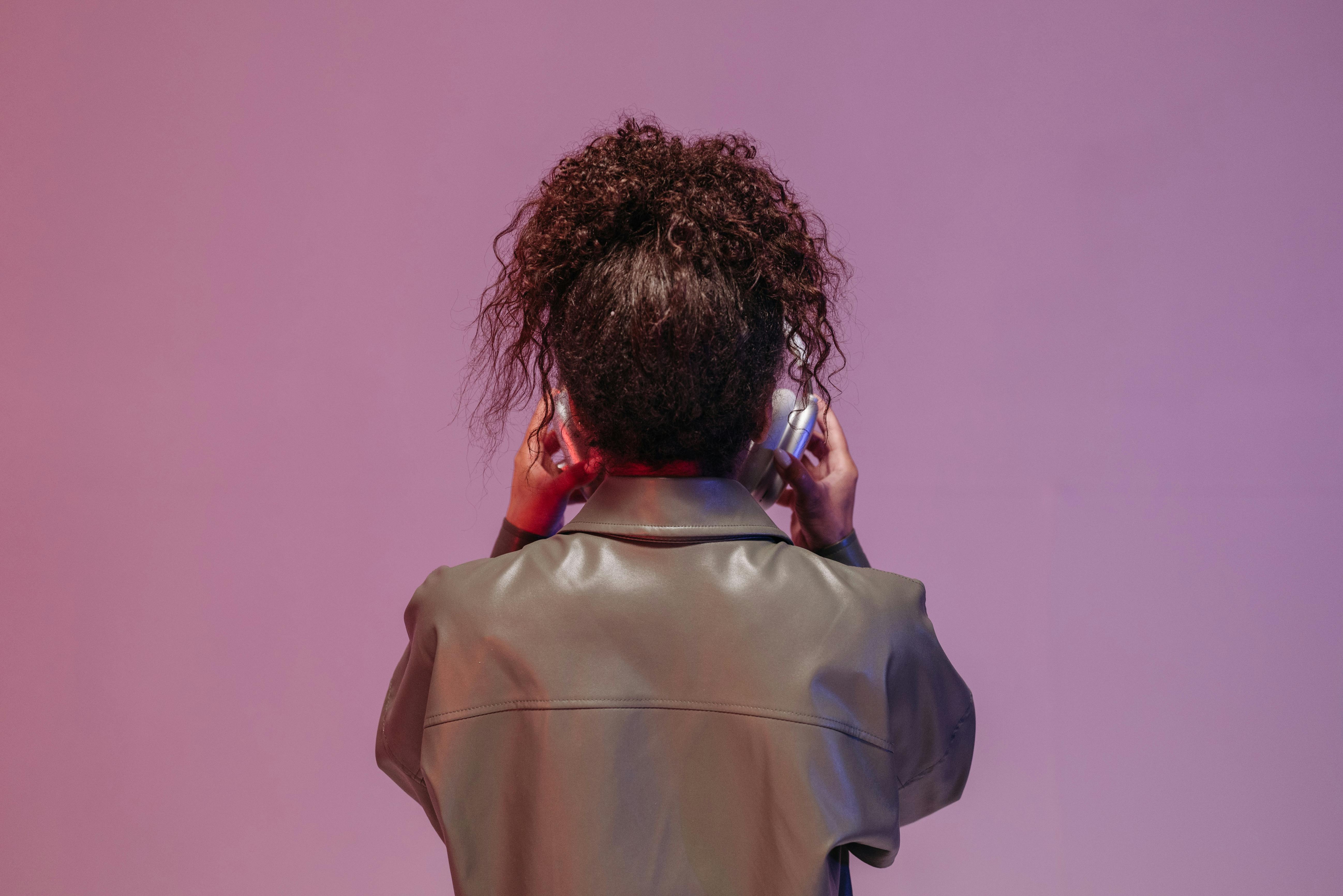 Back View of a Woman Wearing a Headphone · Free Stock Photo