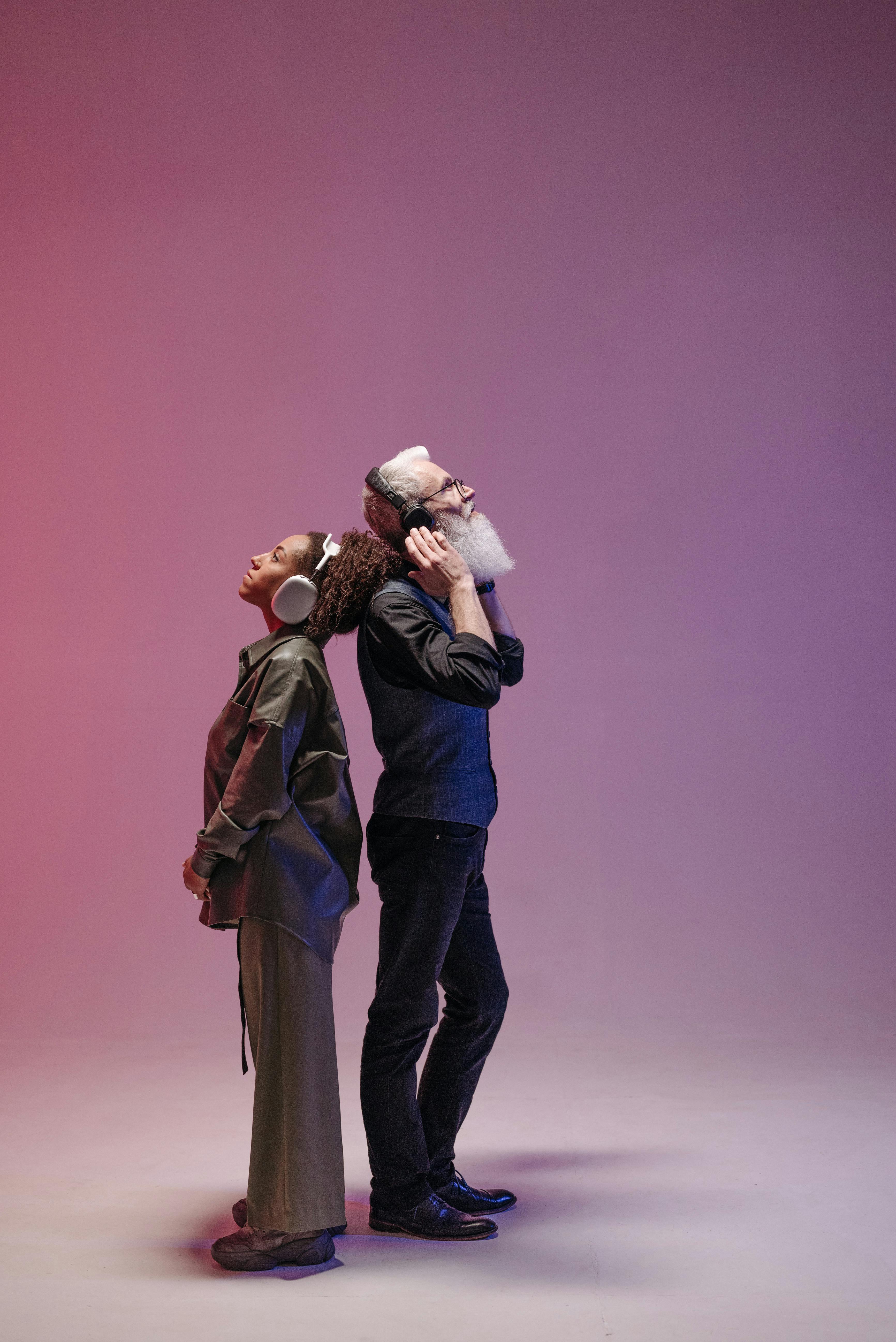 Woman and Man with Headphones Standing Back to Back in Studio · Free ...