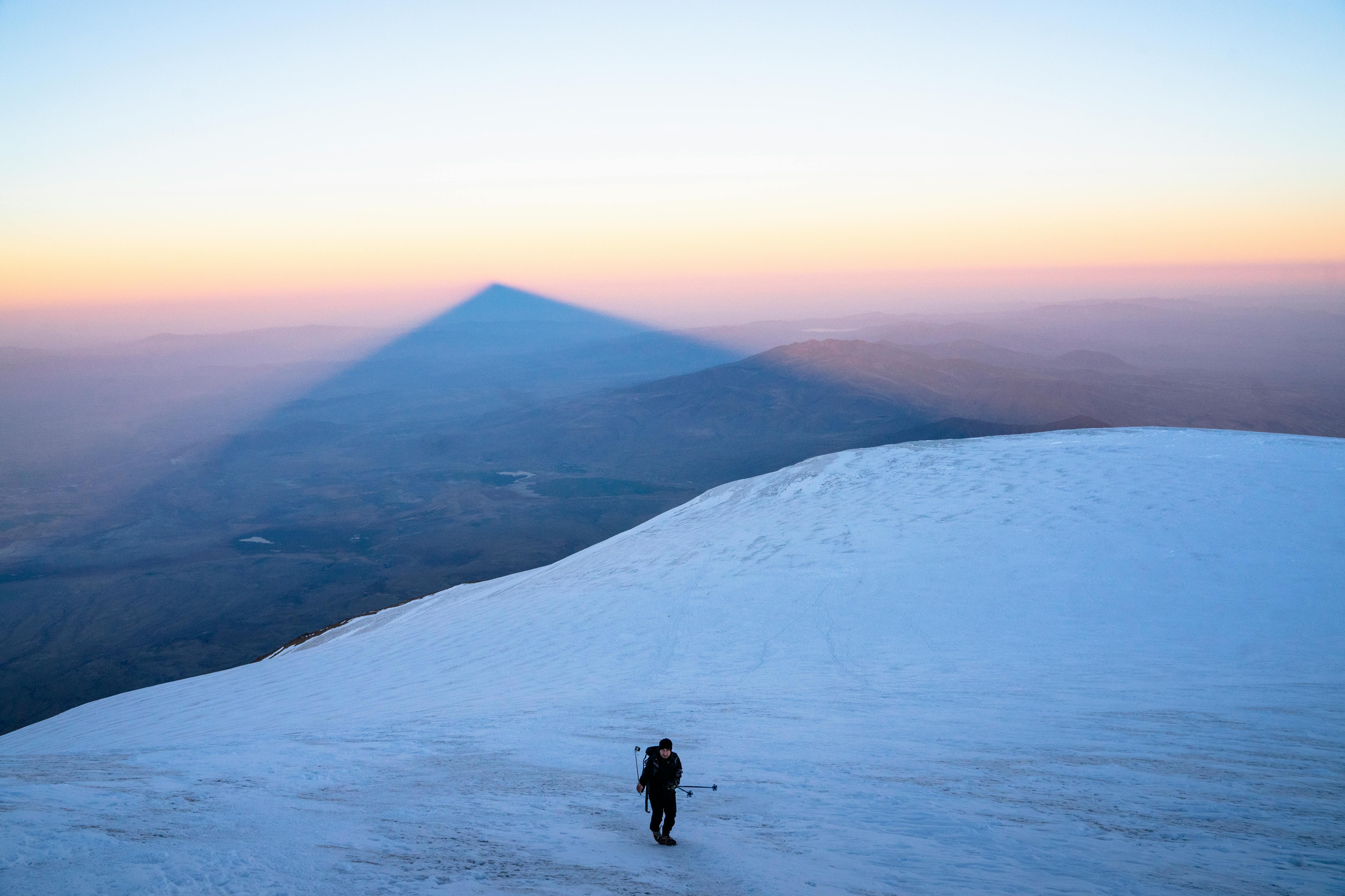 Person Climbing Mountains Covered in Snow · Free Stock Photo