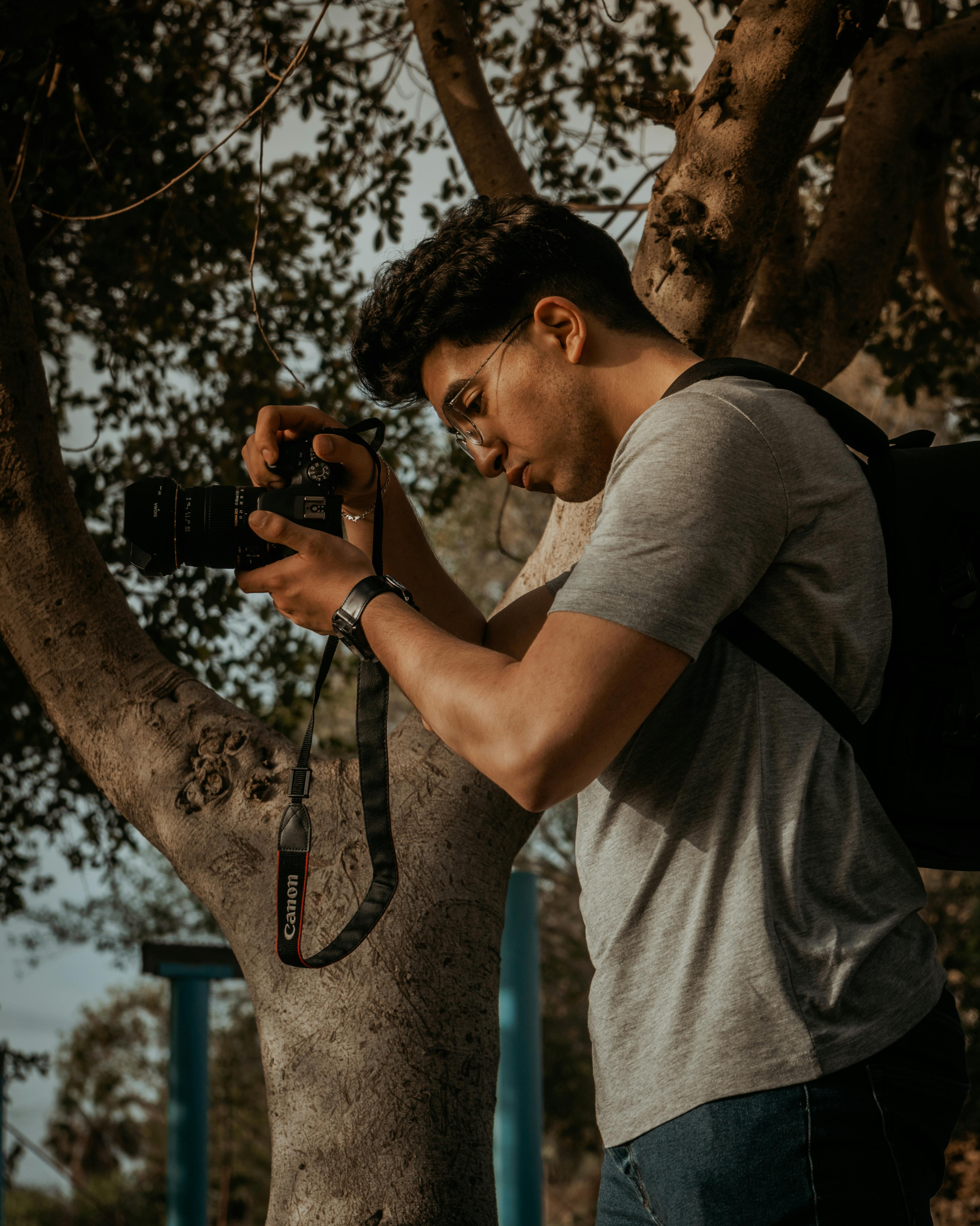 Photography of Man Holding Dslr Camera · Free Stock Photo
