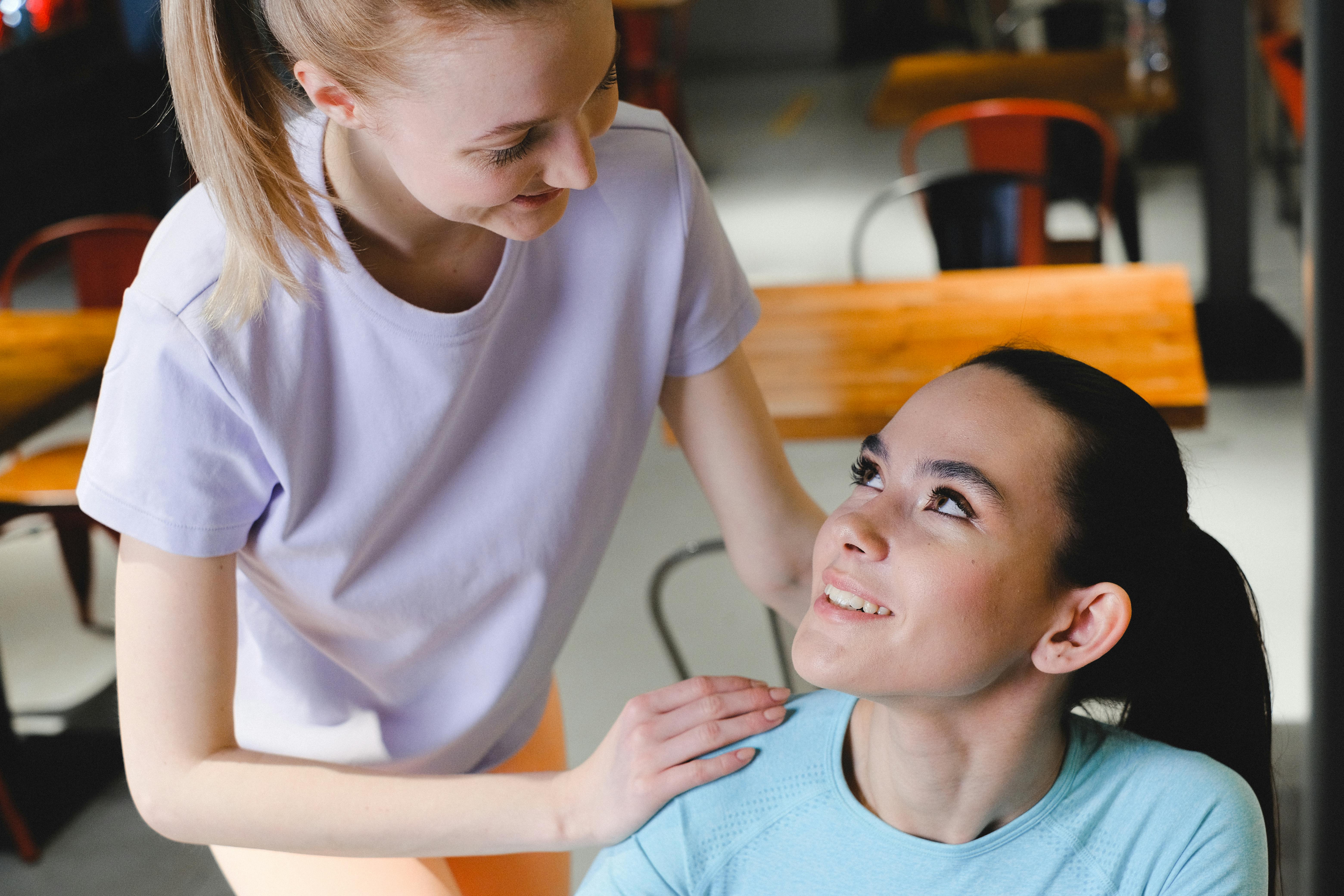 A Woman Touching Another Womans SHoulder · Free Stock Photo