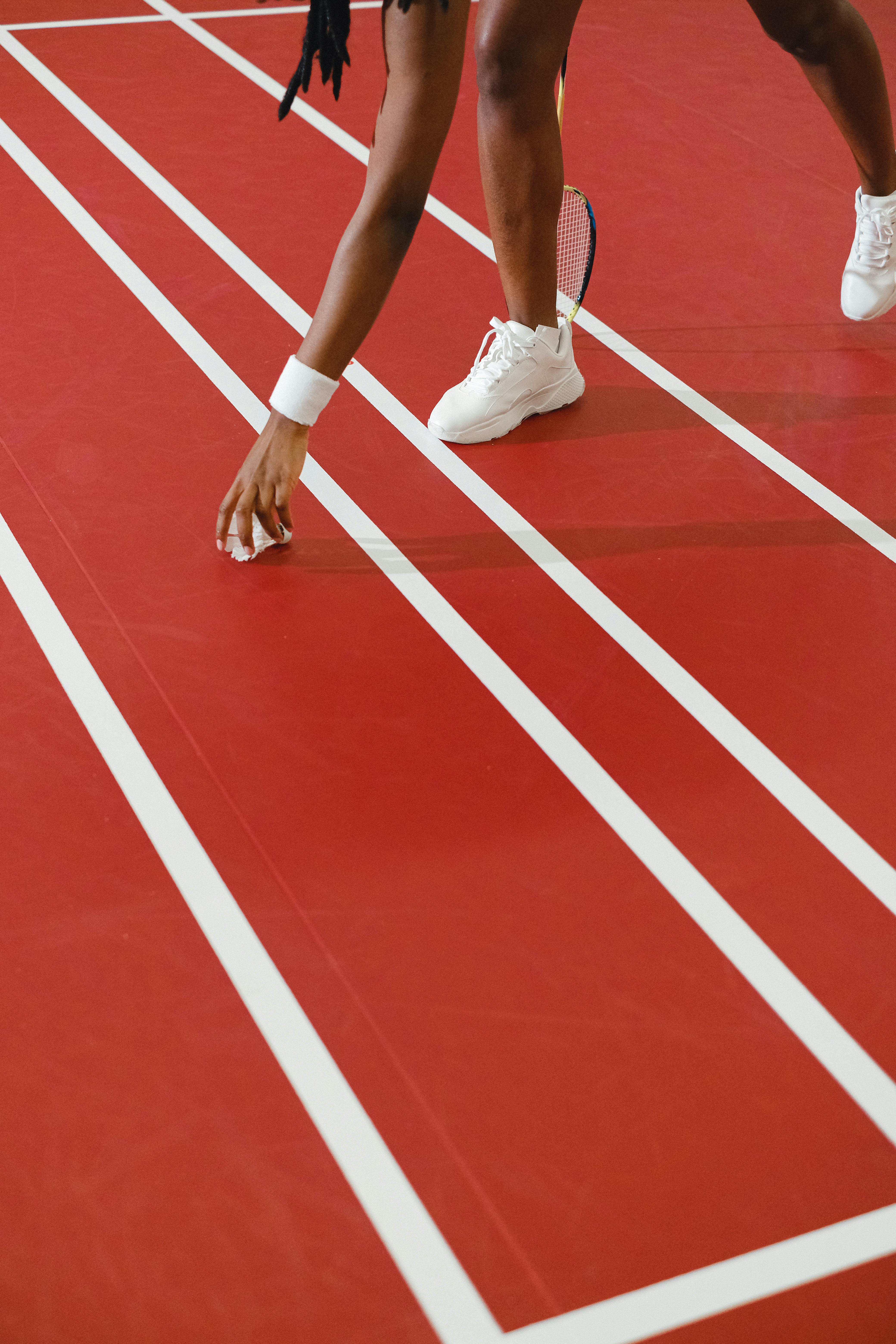 Woman Picking up Badminton Shuttlecock · Free Stock Photo