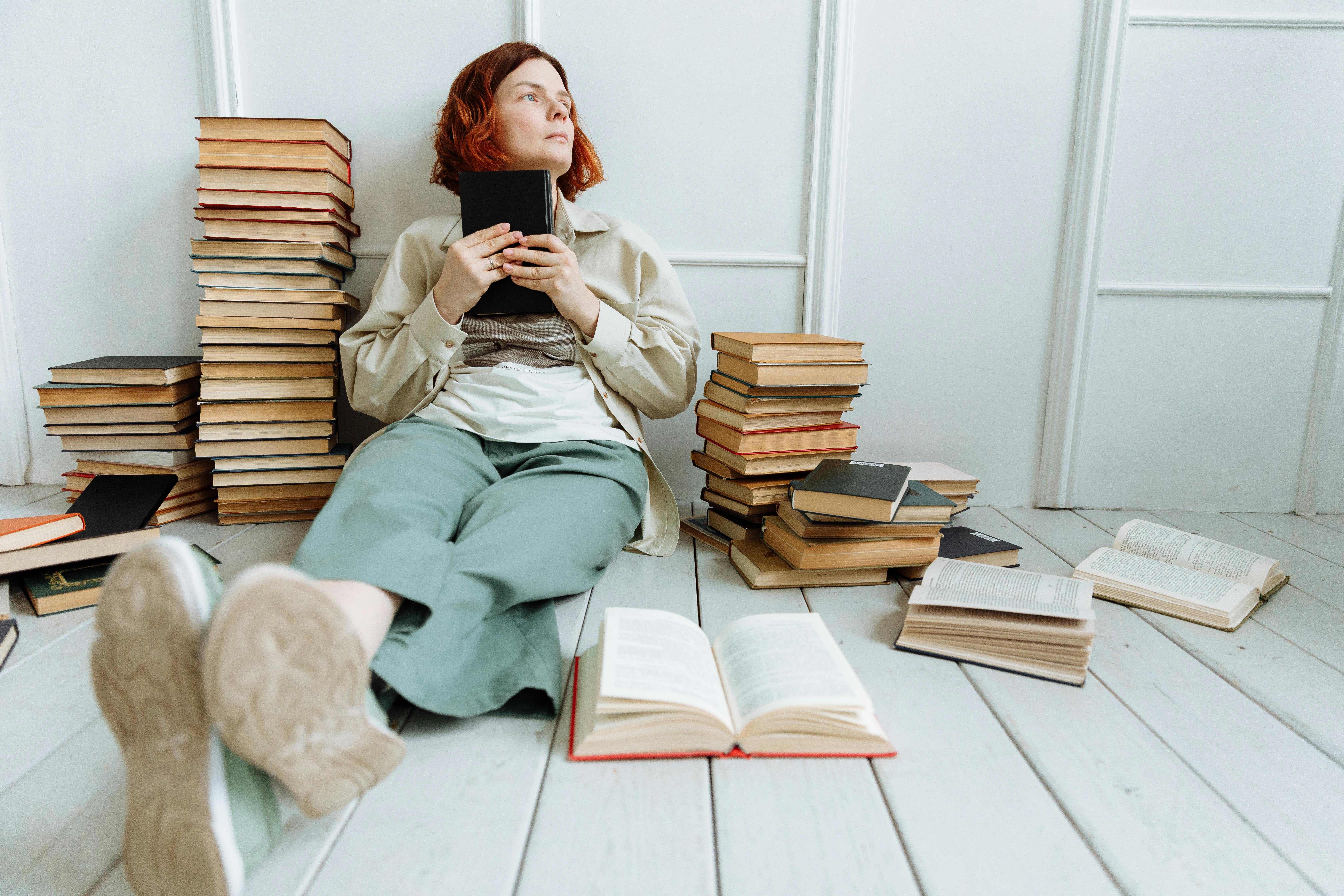 A Woman Sitting holding Book · Free Stock Photo
