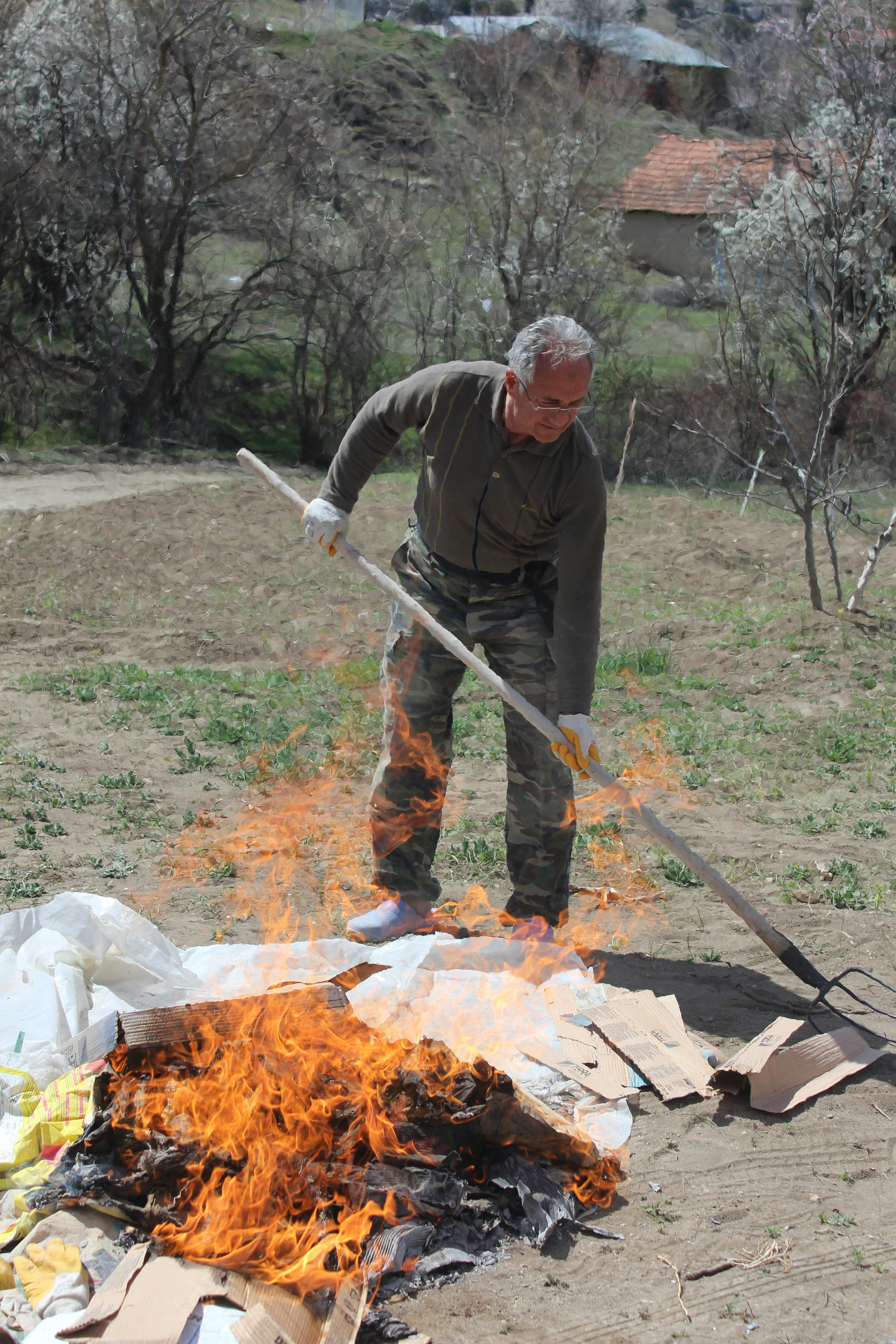 Man Burning Garbage in Countryside · Free Stock Photo
