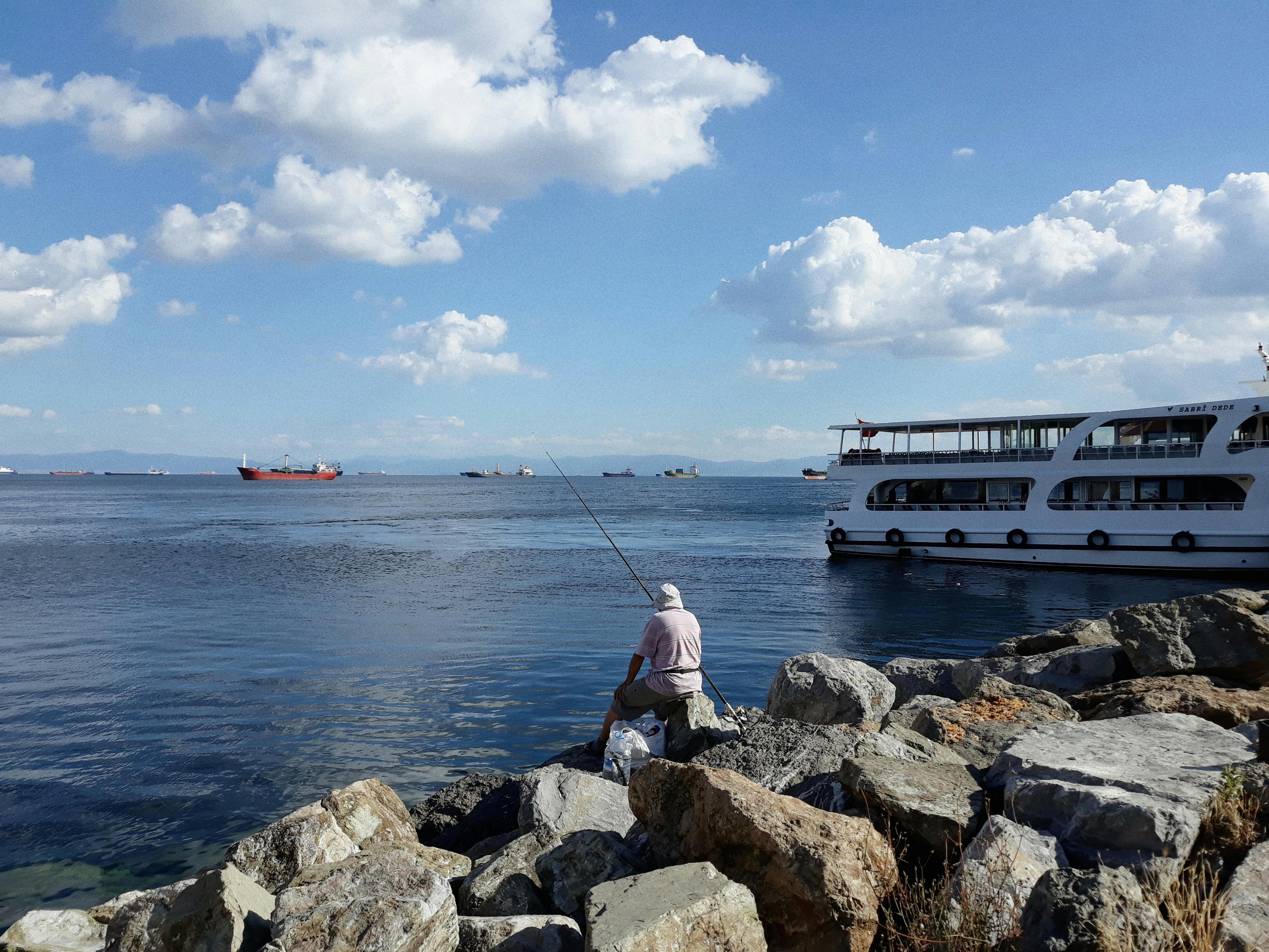 A Man Fishing at the Seaside · Free Stock Photo