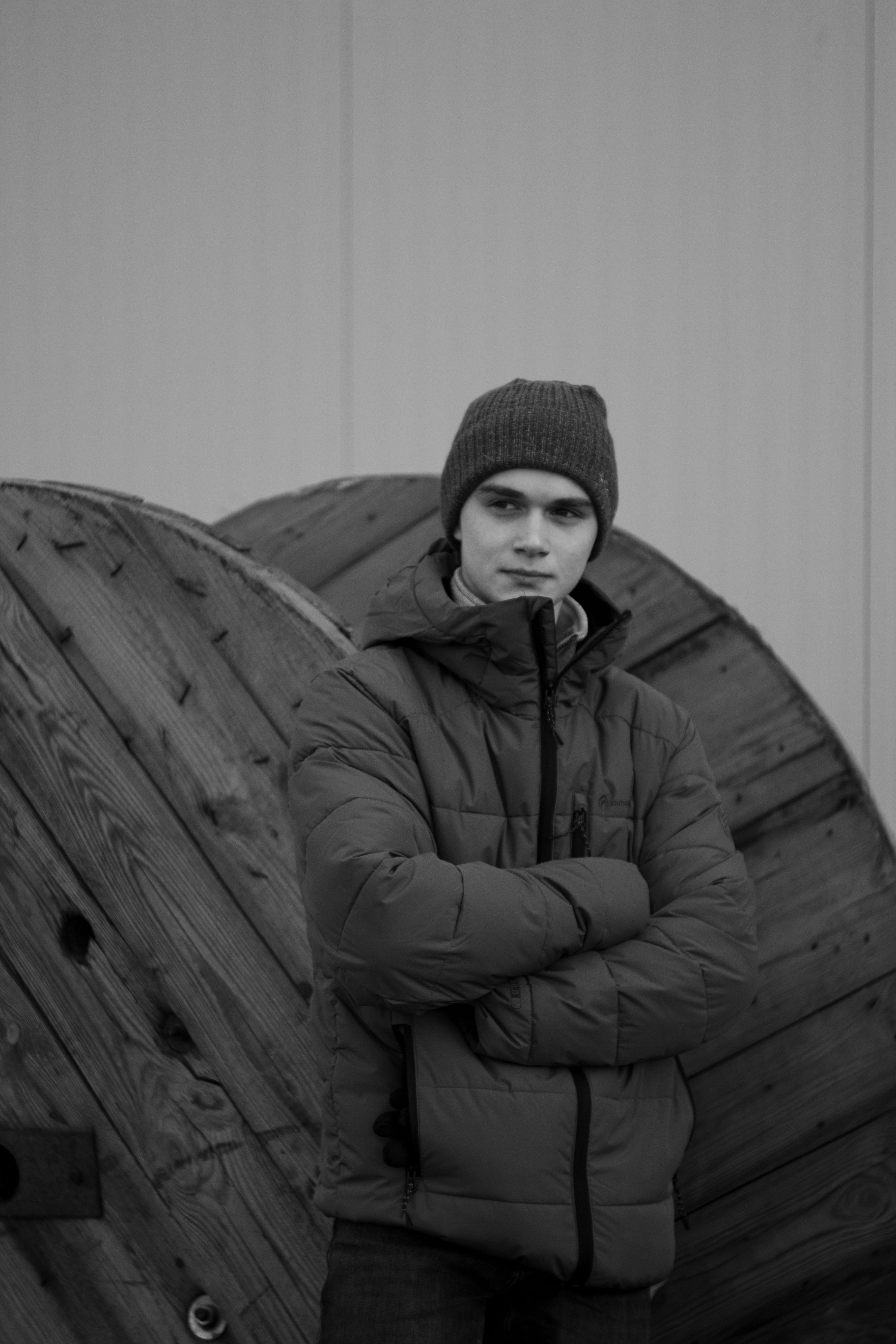 Grayscale Photo of a Man Wearing a Puffer Jacket With His Arms Crossed ...