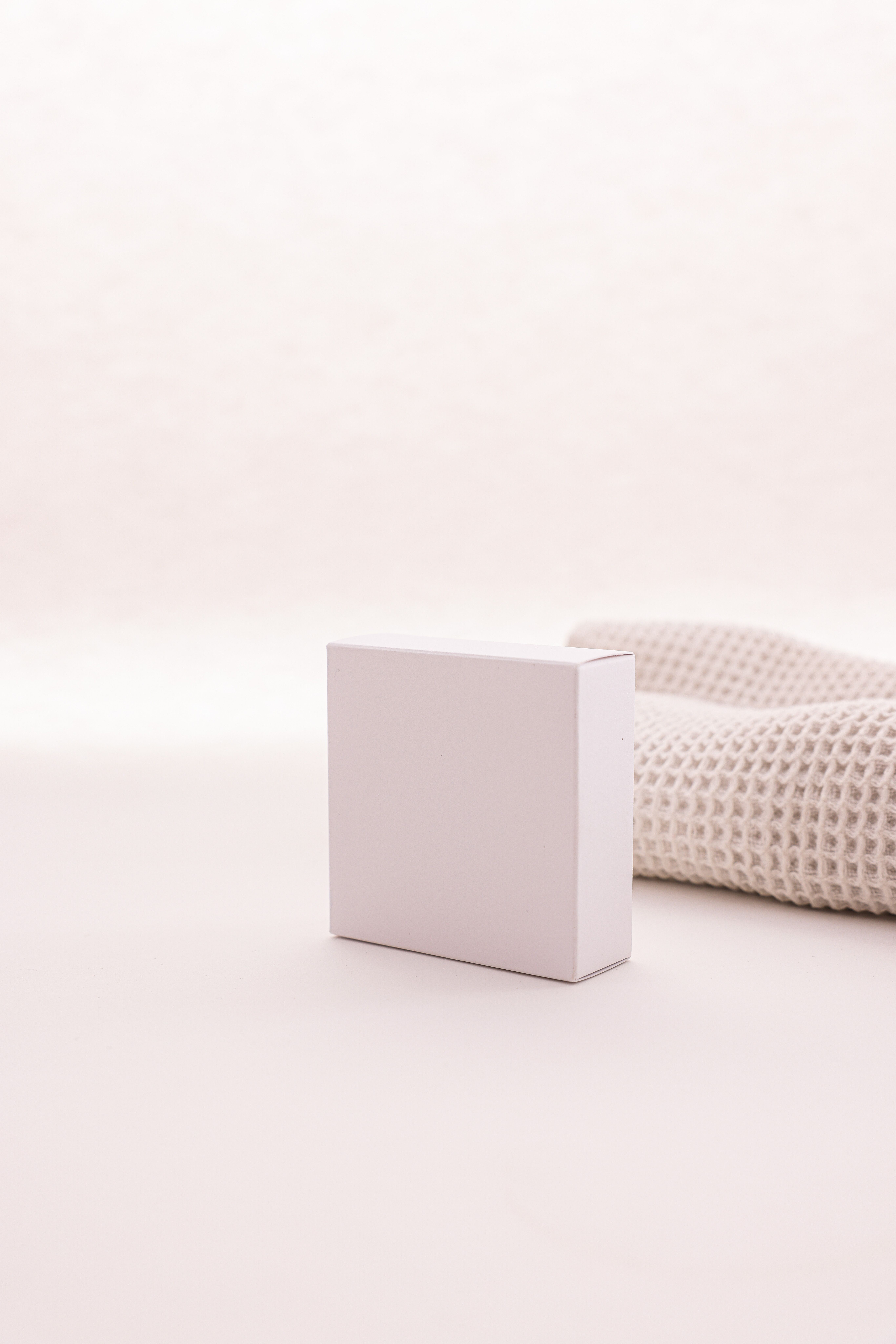 White Paper Box and a Cloth on White Background · Free Stock Photo