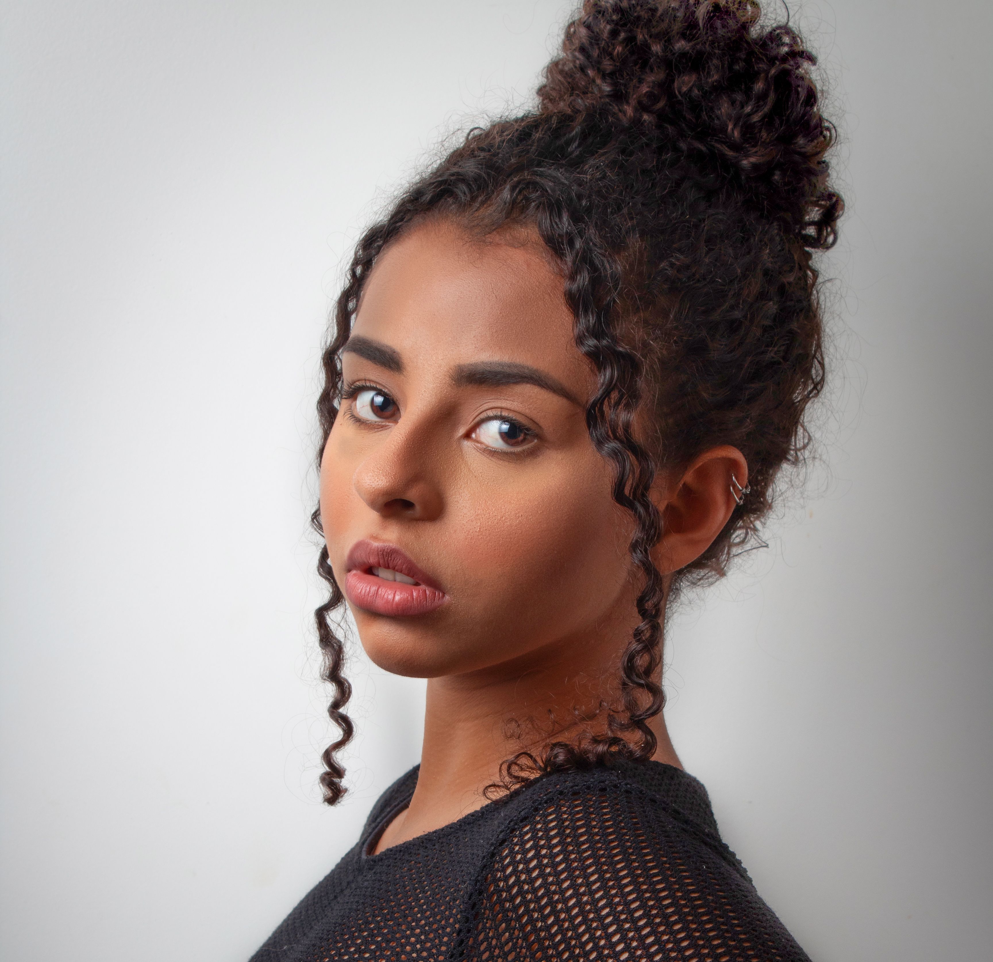 Curled Hair Woman Making a Pose · Free Stock Photo