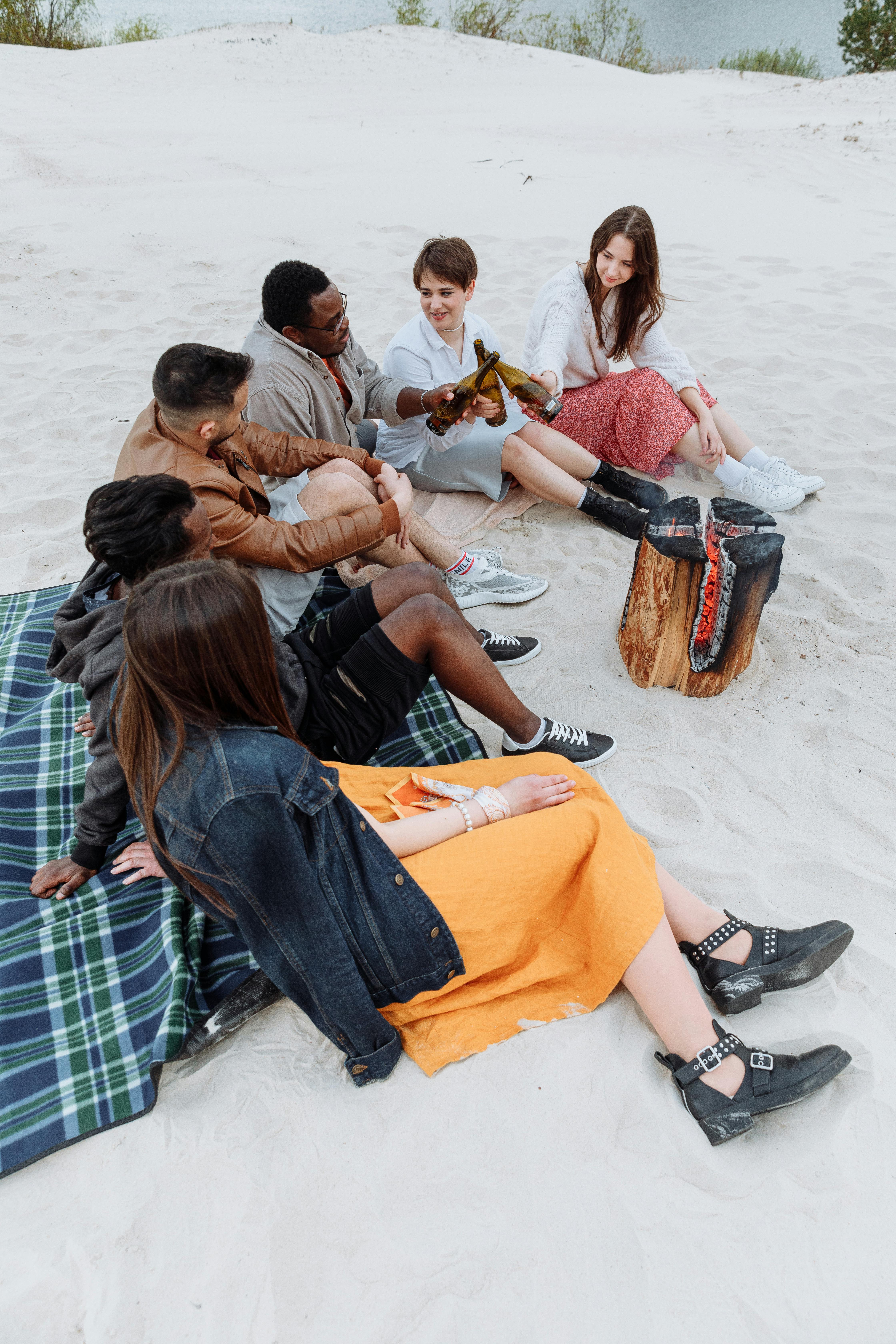 Group of Friends Sitting on Sand · Free Stock Photo