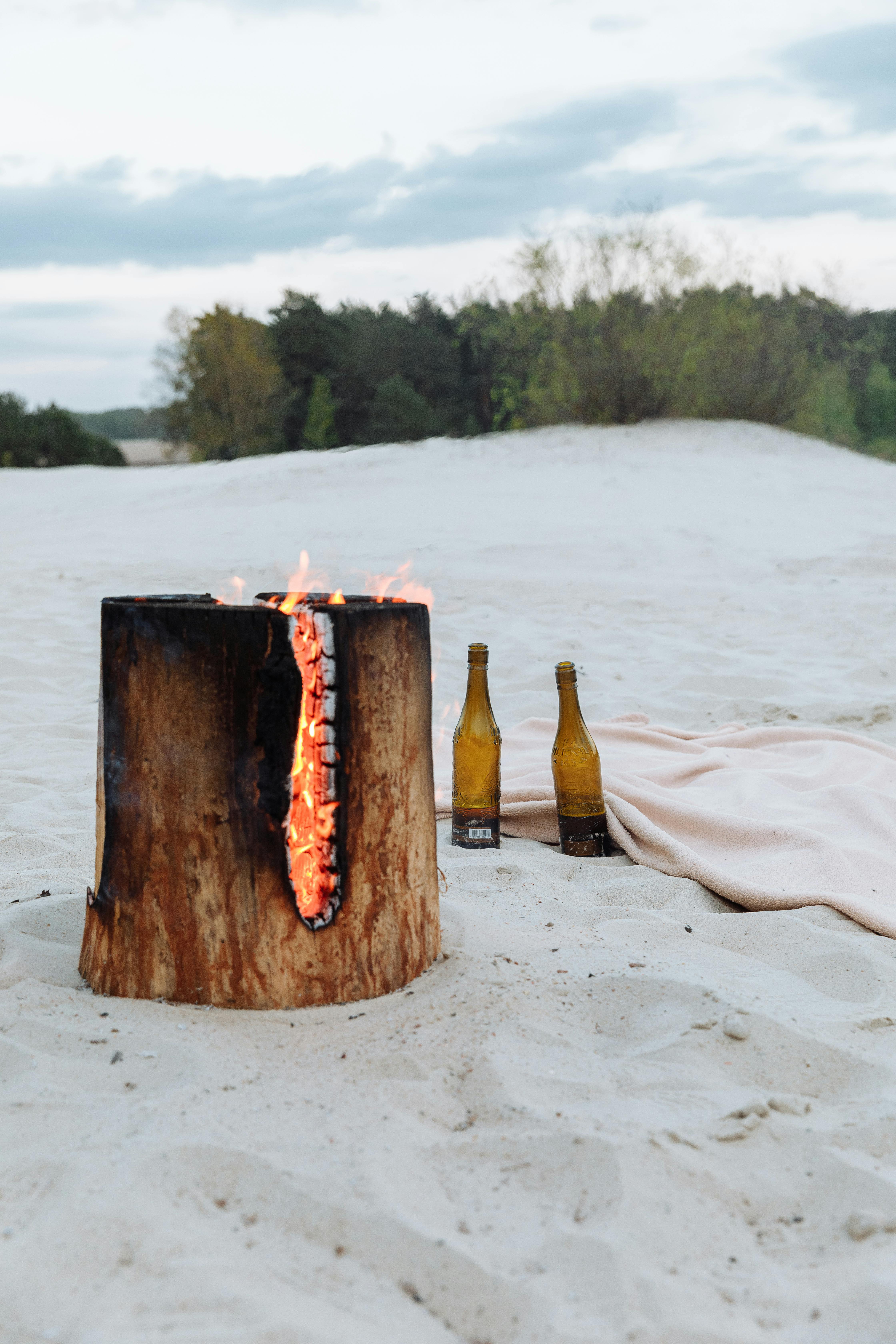 A Swedish Fire and Drinks on the Sand · Free Stock Photo