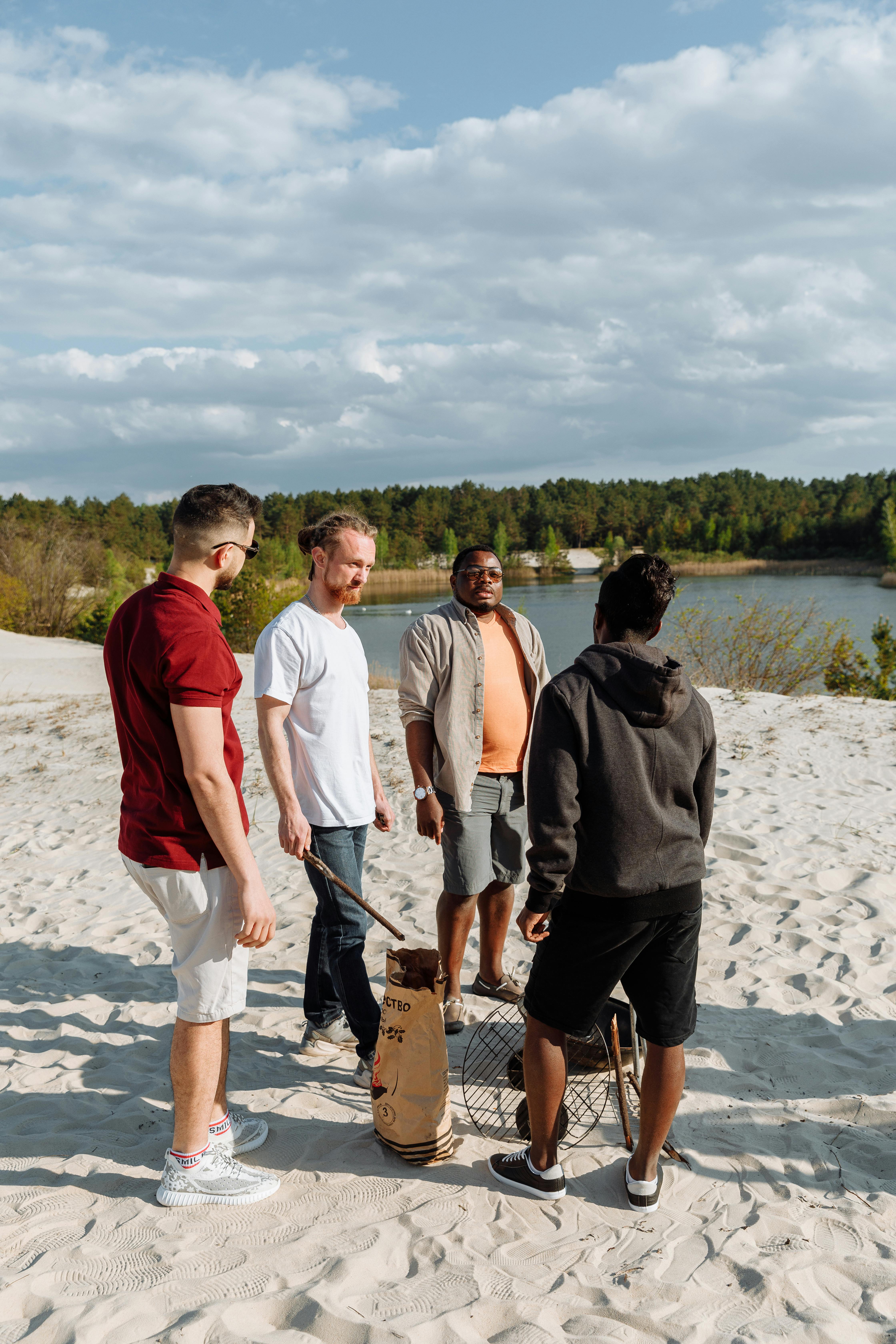Group of Men Standing Around a Barbecue Grill and Talking · Free Stock ...