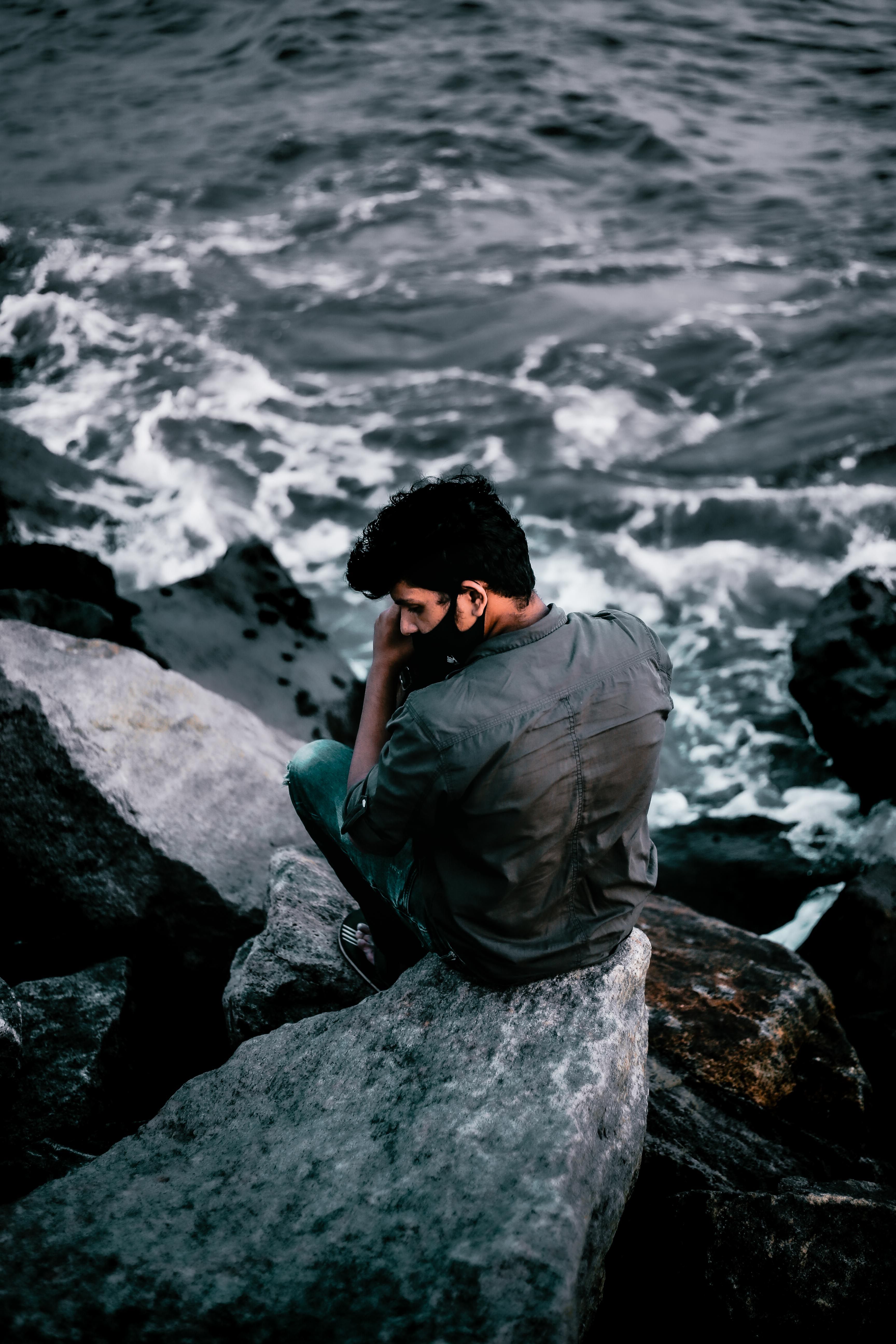 A Man Sitting on a Rock · Free Stock Photo