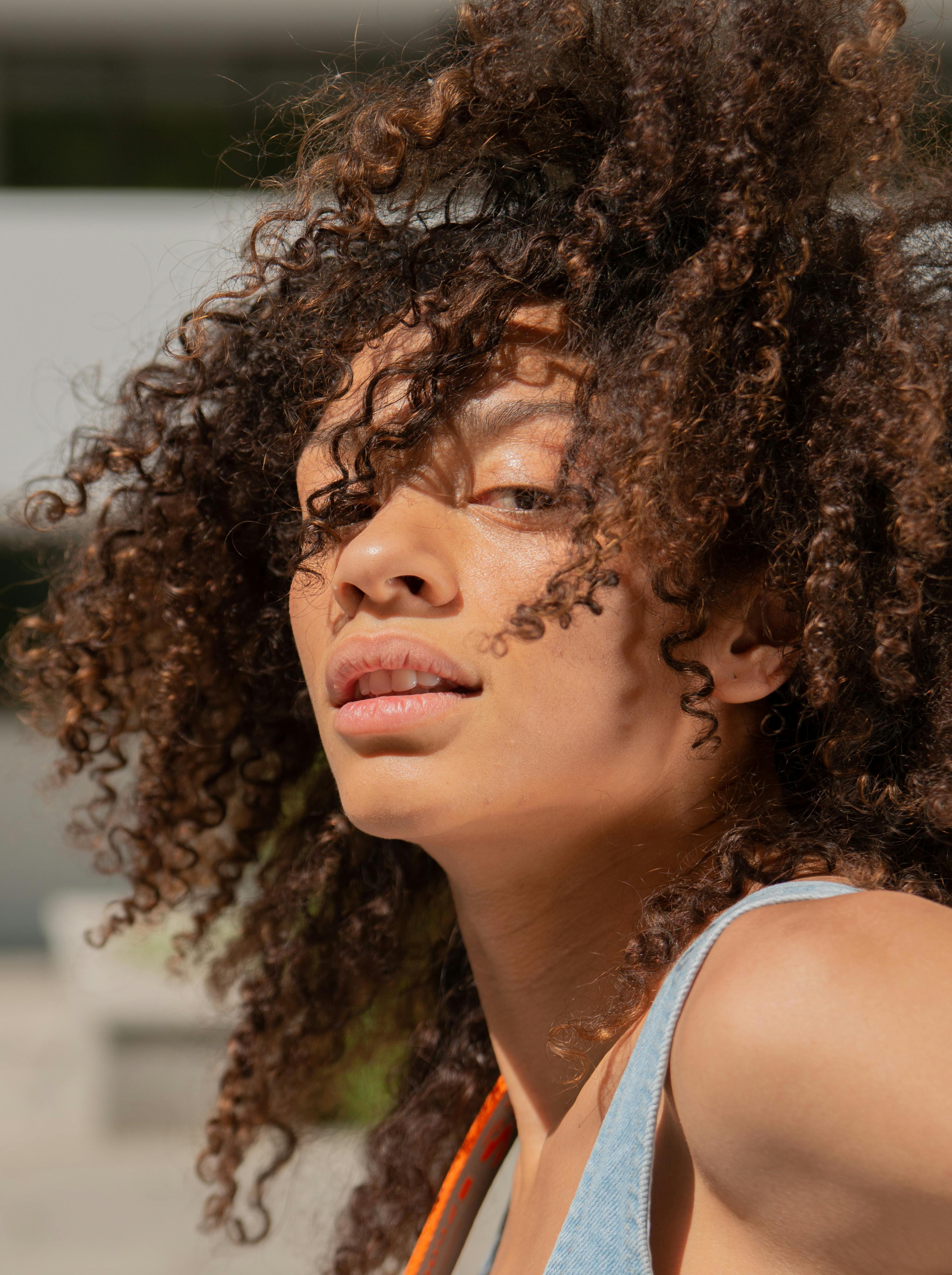 Close Up Photo of a Woman with Curly Hair · Free Stock Photo