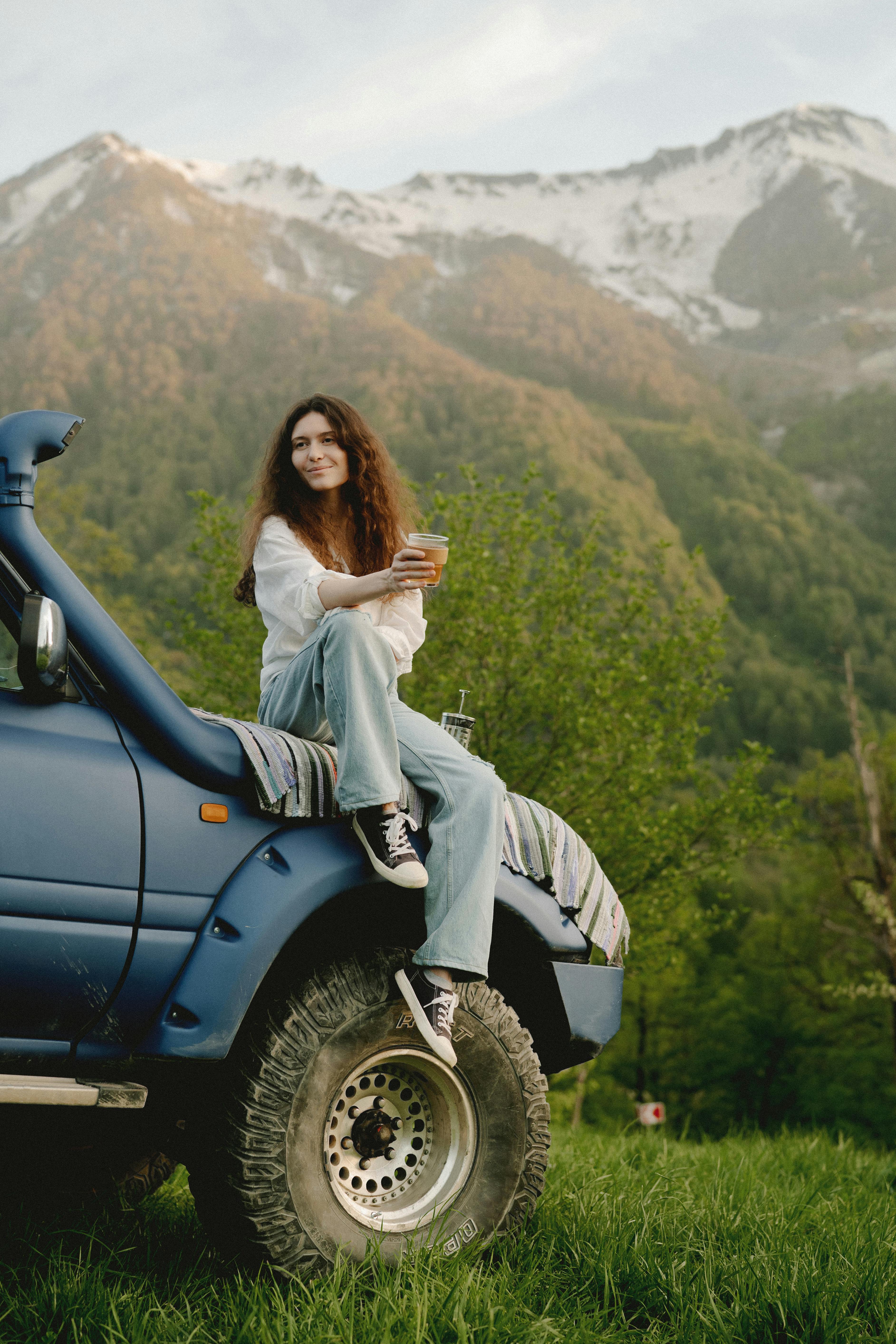 Woman sitting on a 4x4 Truck · Free Stock Photo