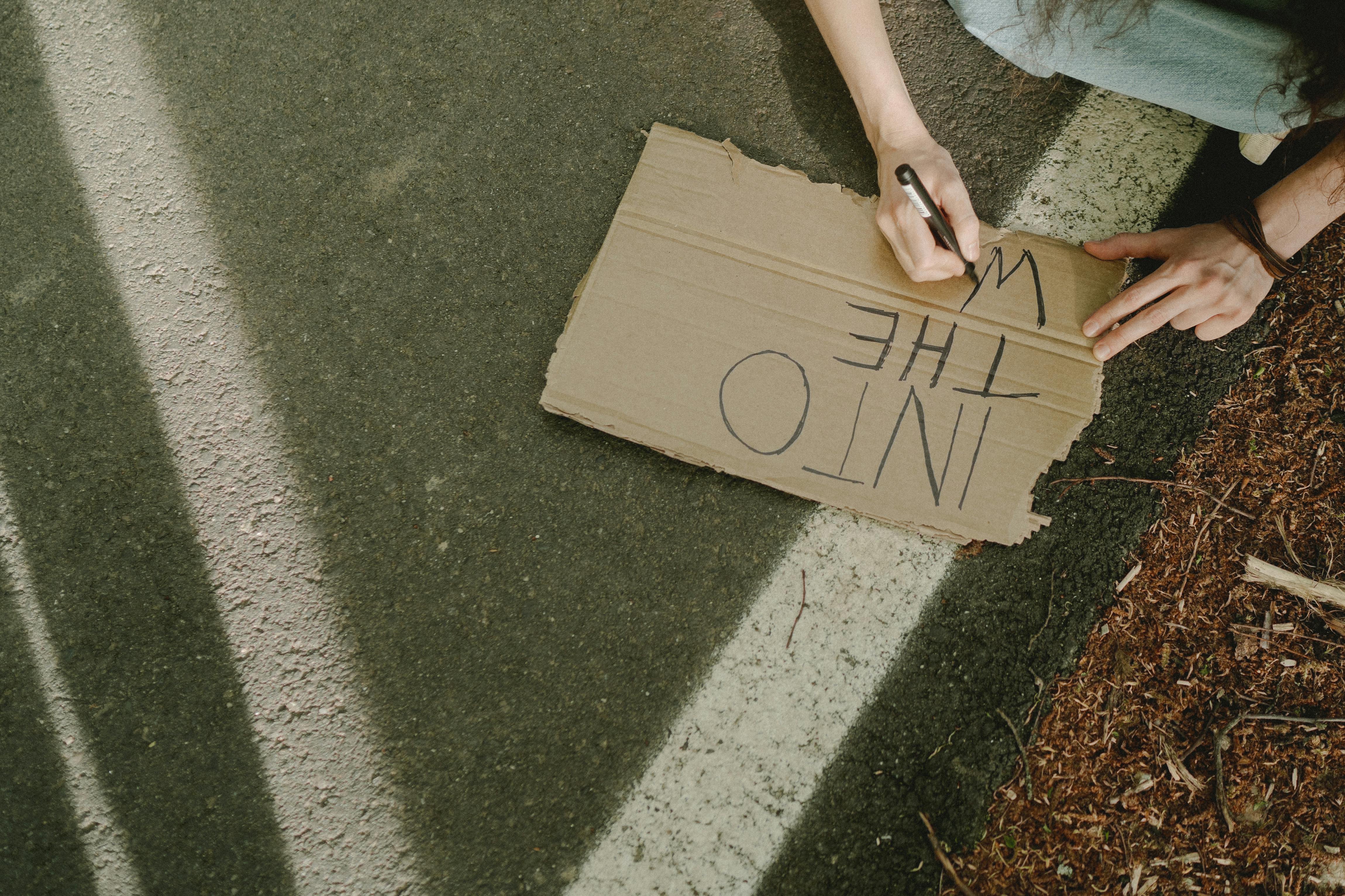 Person Writing on a Cardboard · Free Stock Photo