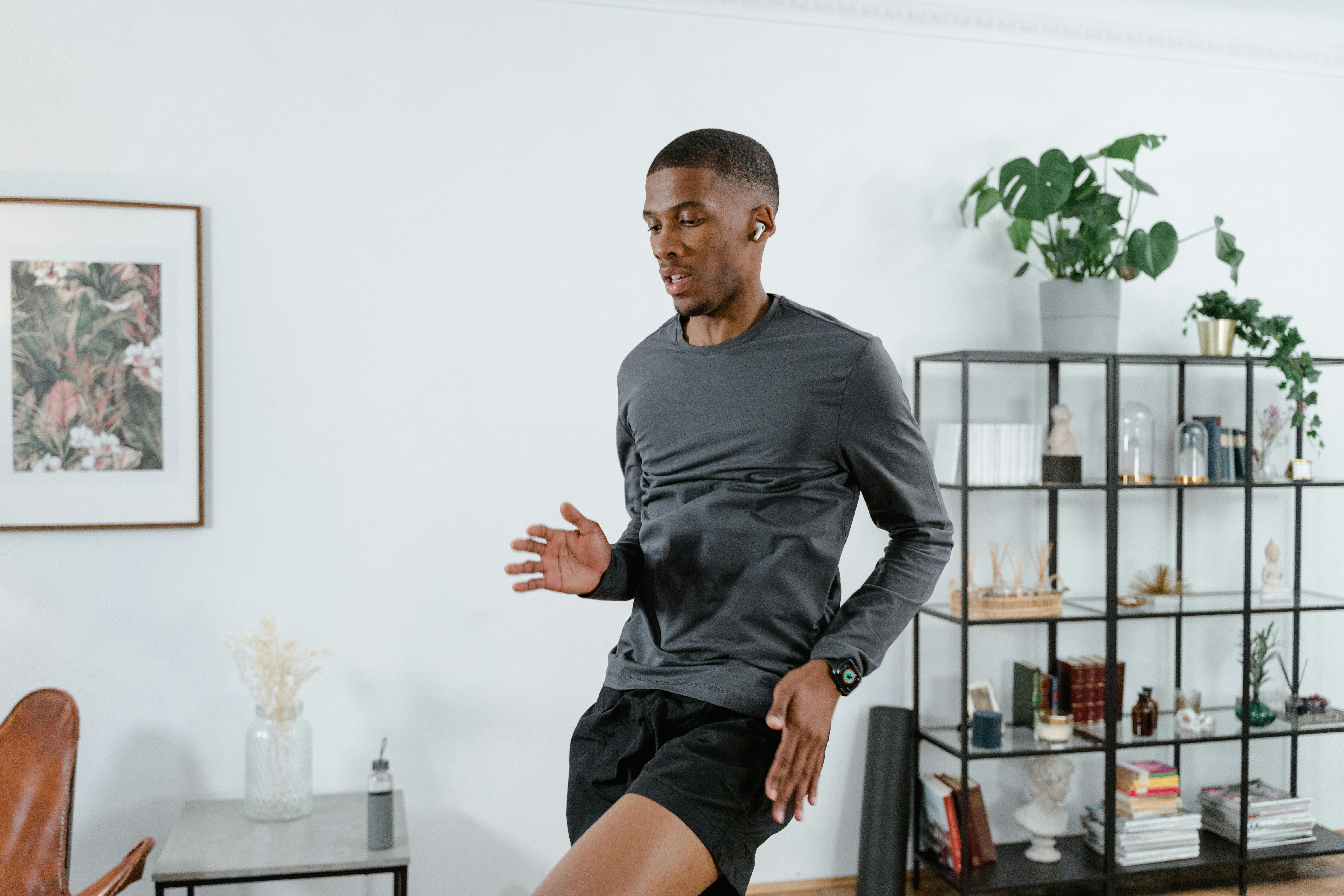 Man in Activewear Exercising Indoors · Free Stock Photo