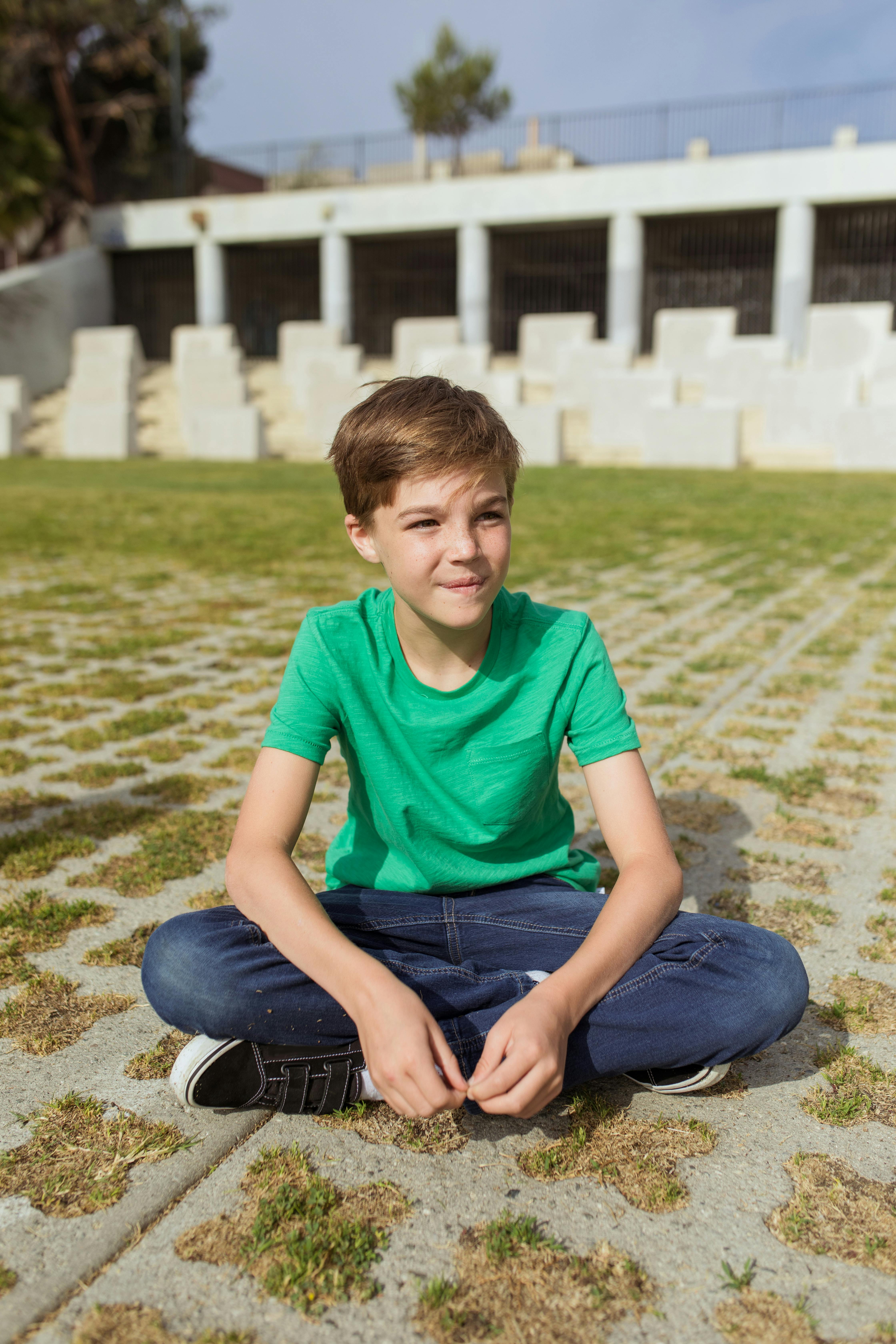 Photo of Boy Sitting on Ground · Free Stock Photo