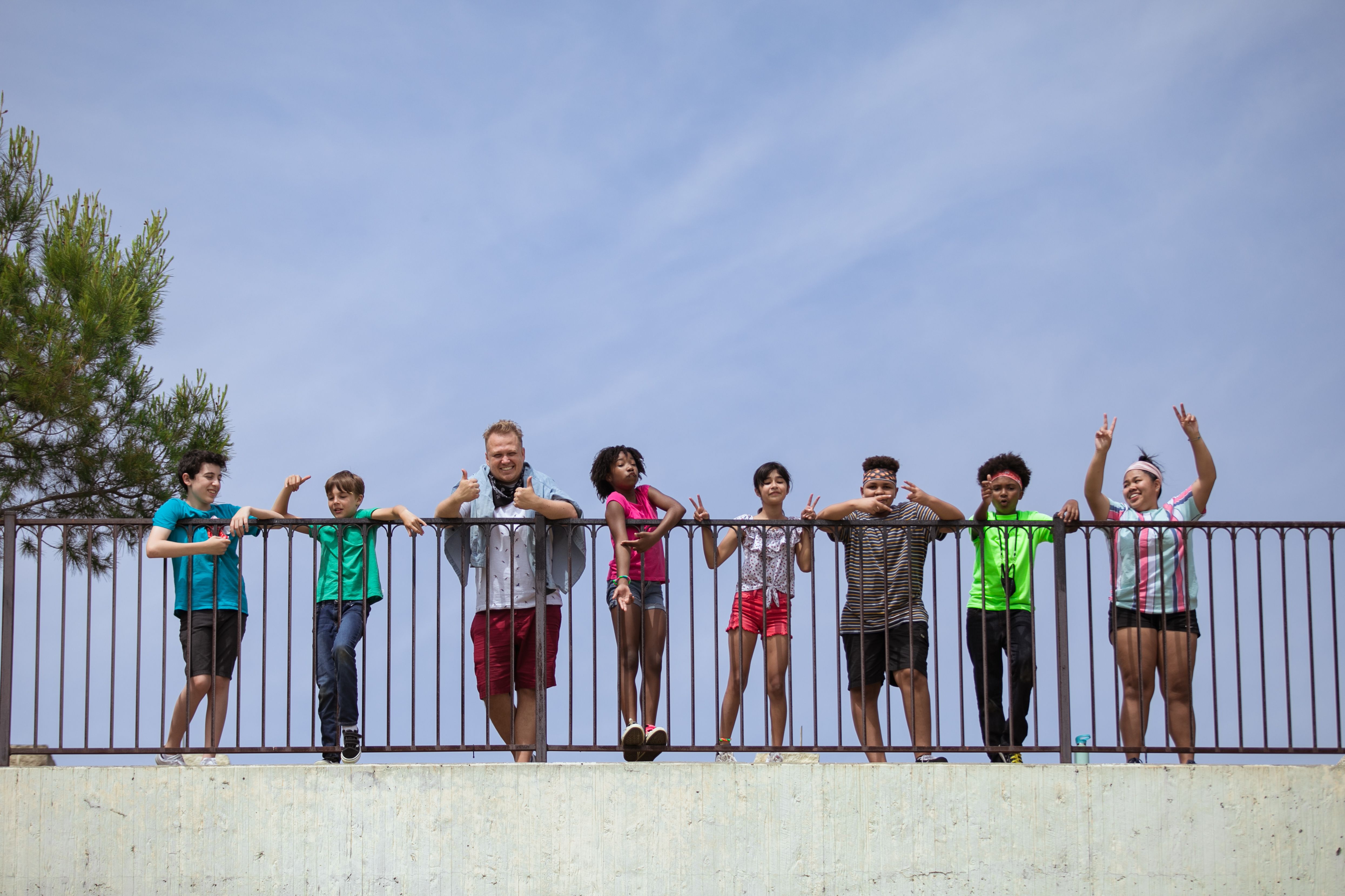 People Standing Behind Metal Fence · Free Stock Photo