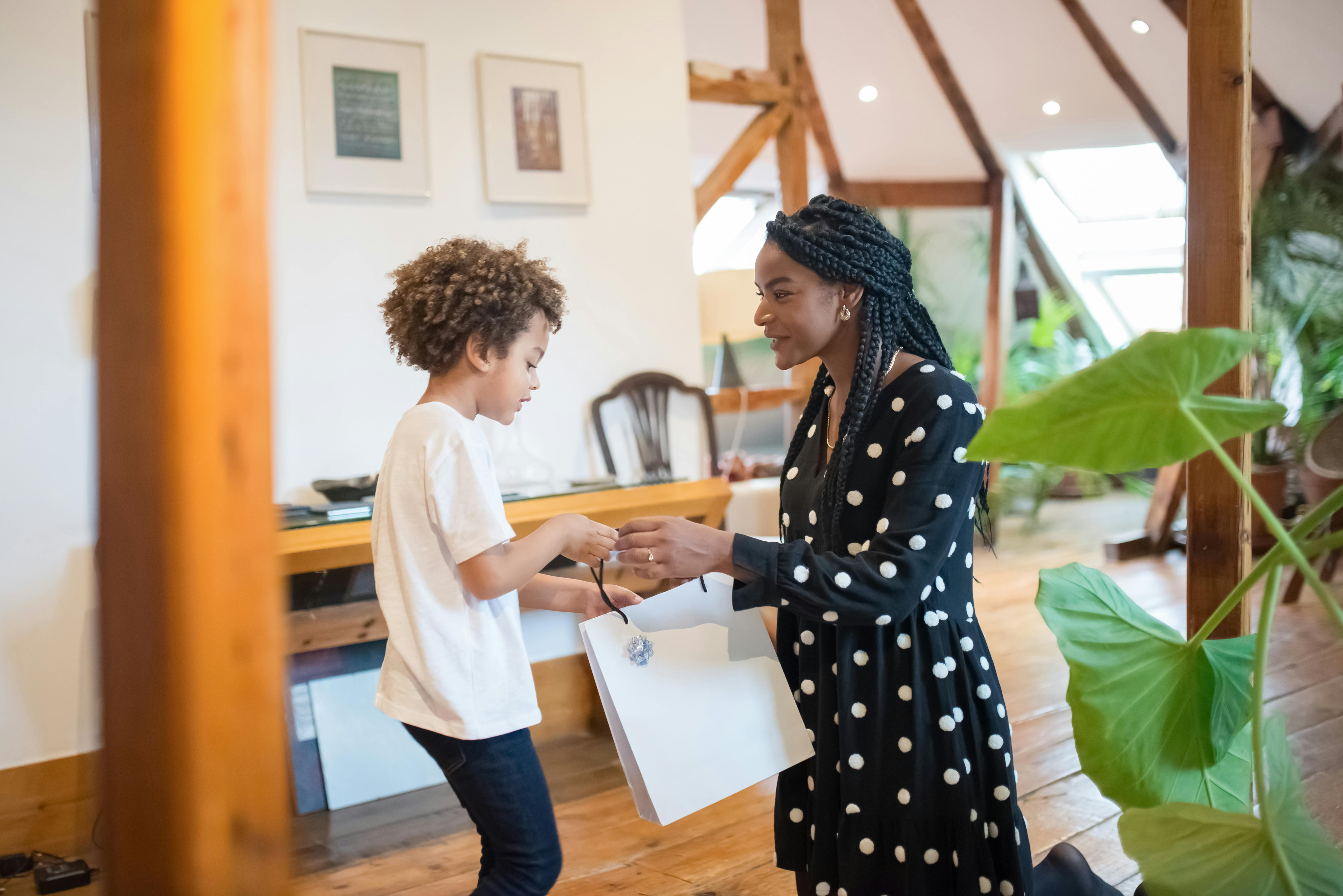 Parent Giving A Child A Gift Photos, Download The BEST Free Parent ...