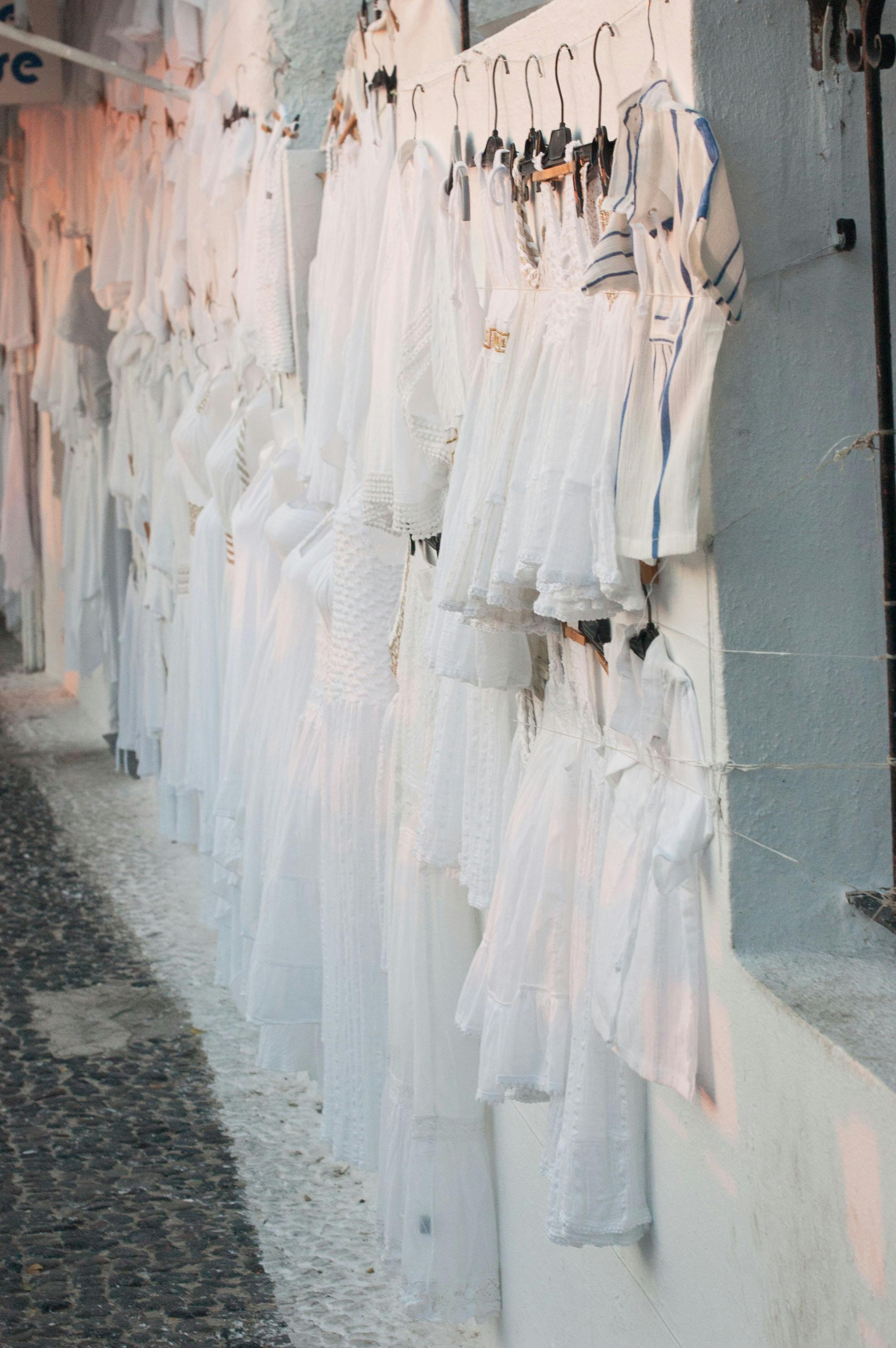 Assorted Dresses Hanged on White Painted Wall · Free Stock Photo