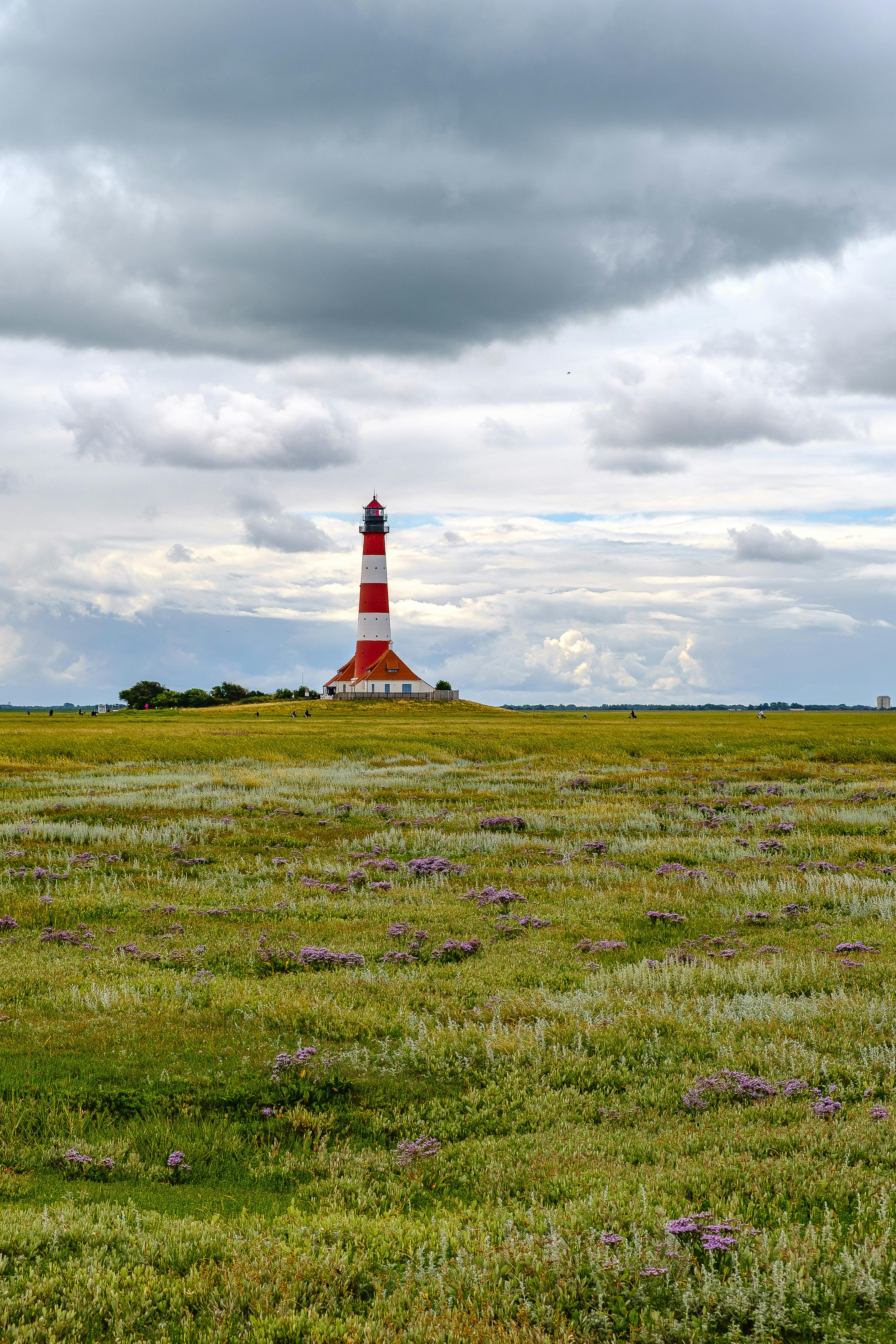 Landscape Scenery of an Open Field Across the Lighthouse · Free Stock Photo