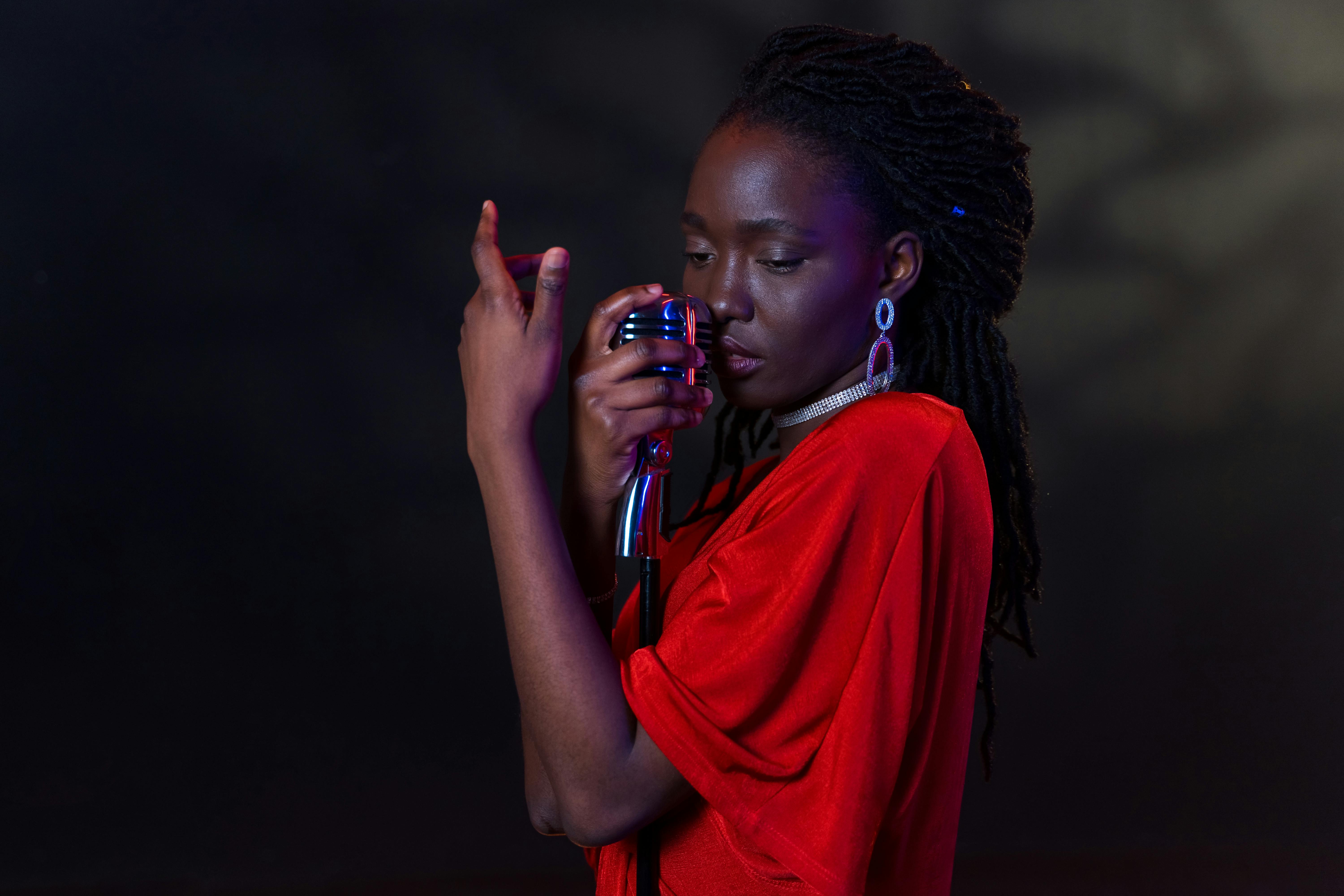 A Woman Holding a Microphone · Free Stock Photo