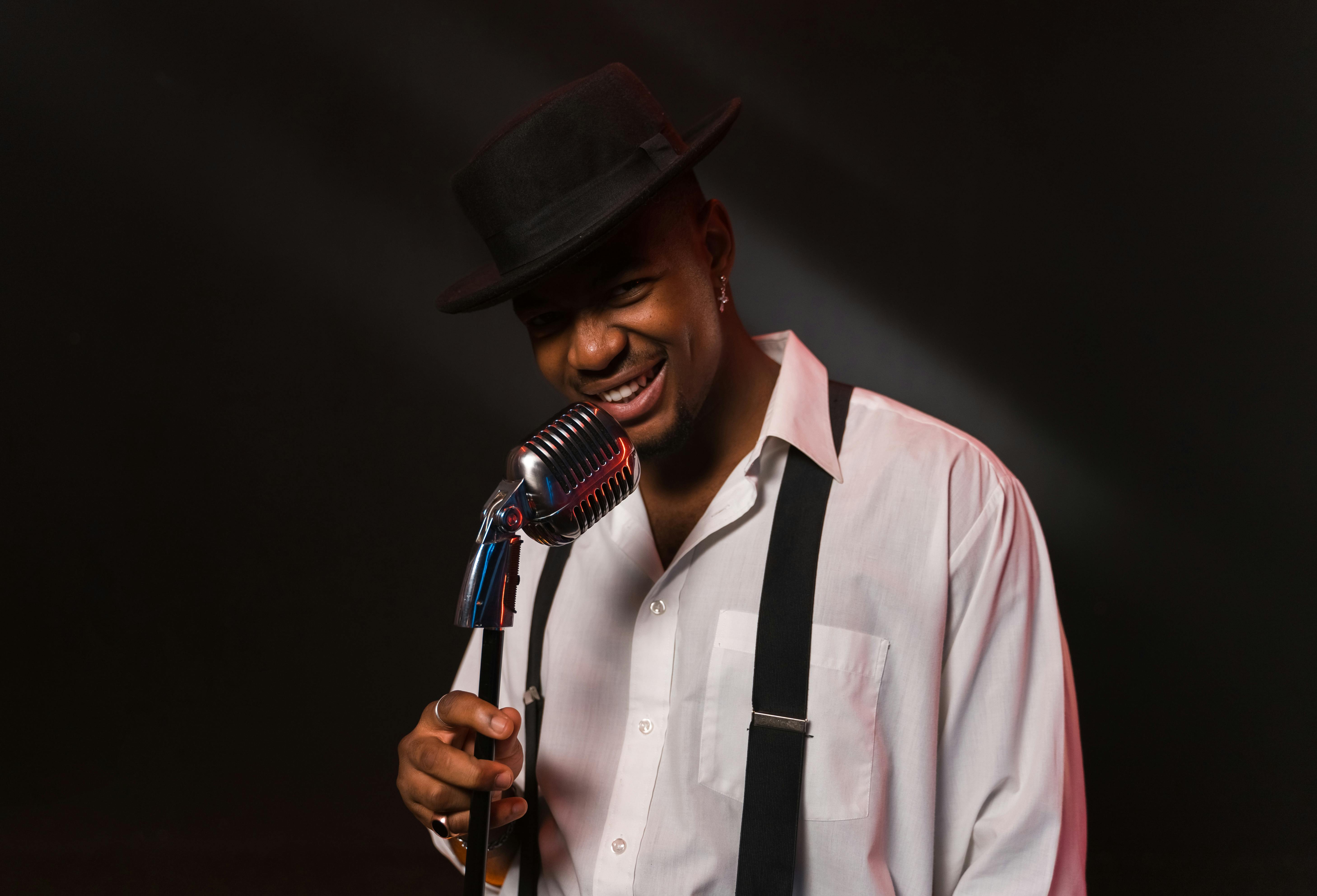 A Man Holding a Microphone · Free Stock Photo