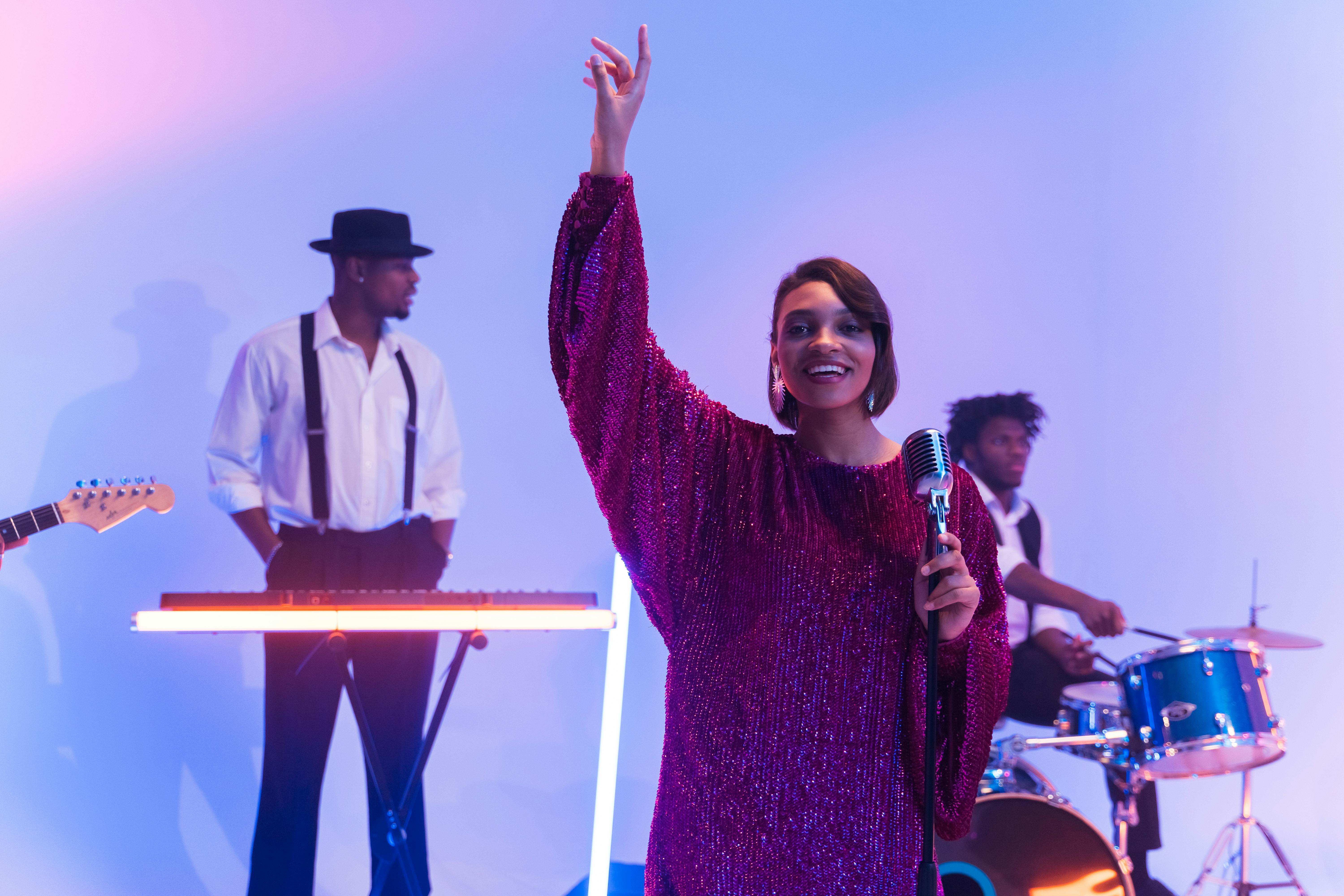 Woman Singing with Arm Raised · Free Stock Photo