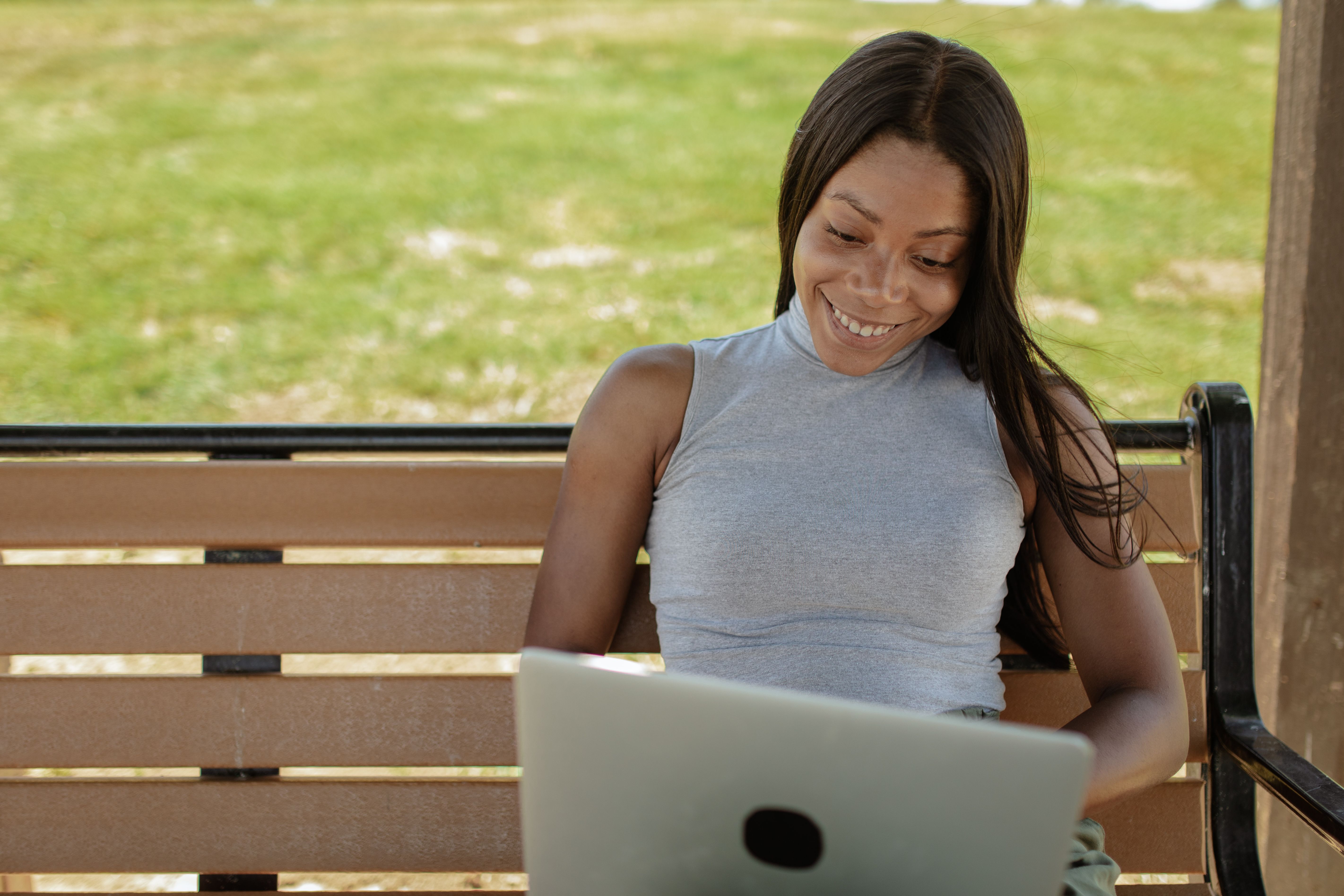 Smiling People Looking at Laptop · Free Stock Photo