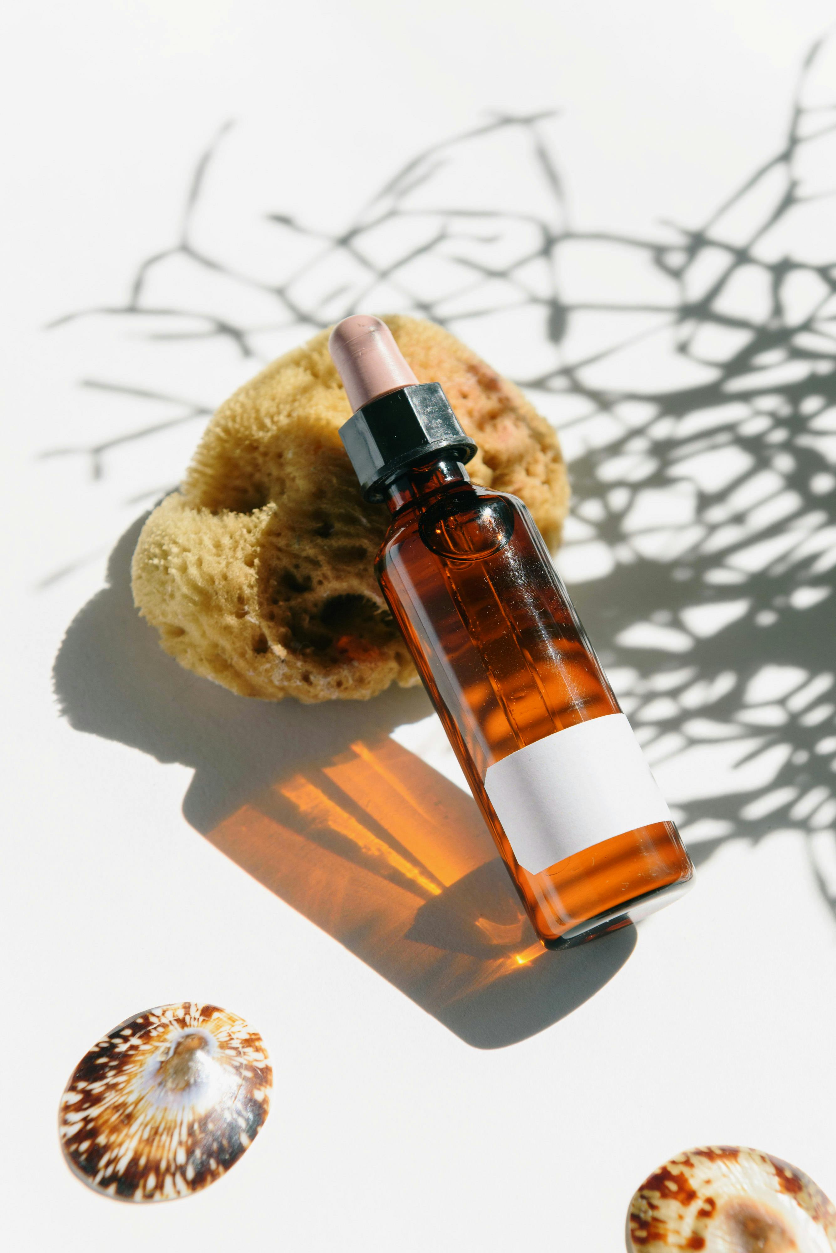 Essential Oil Bottle and a Sponge · Free Stock Photo