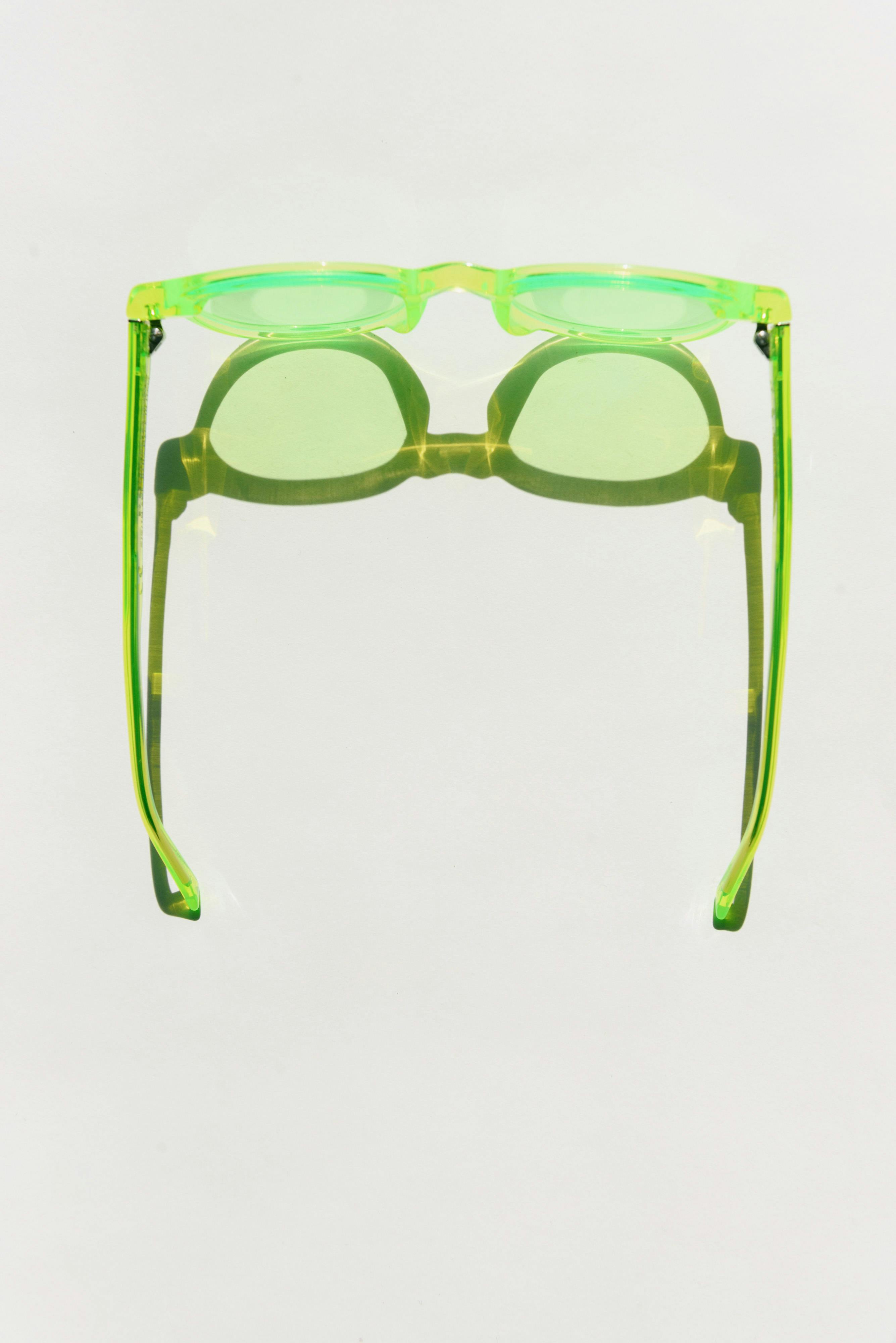 Green Framed Eyeglasses on White Surface · Free Stock Photo