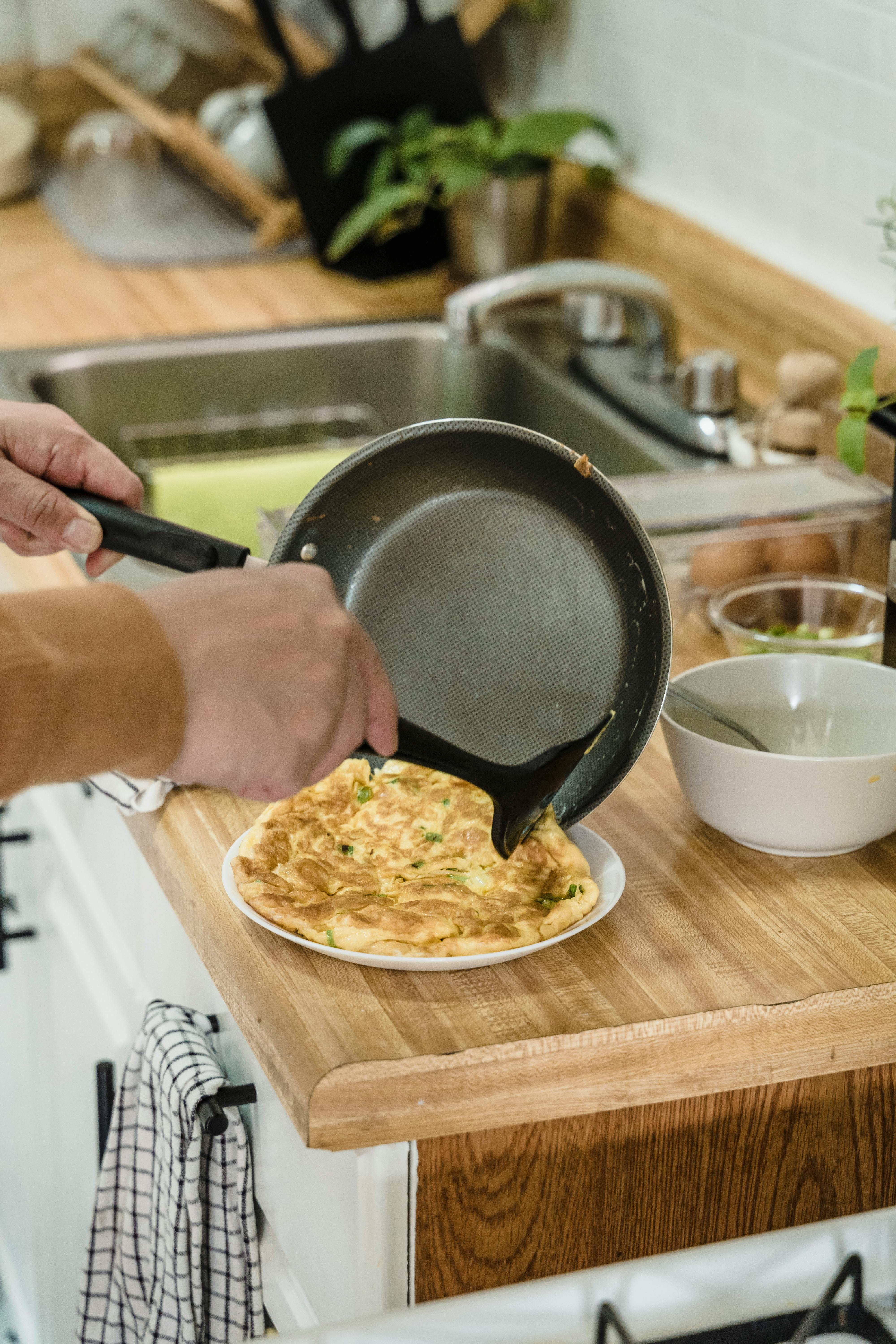 A Person Holding Black Frying Pan · Free Stock Photo