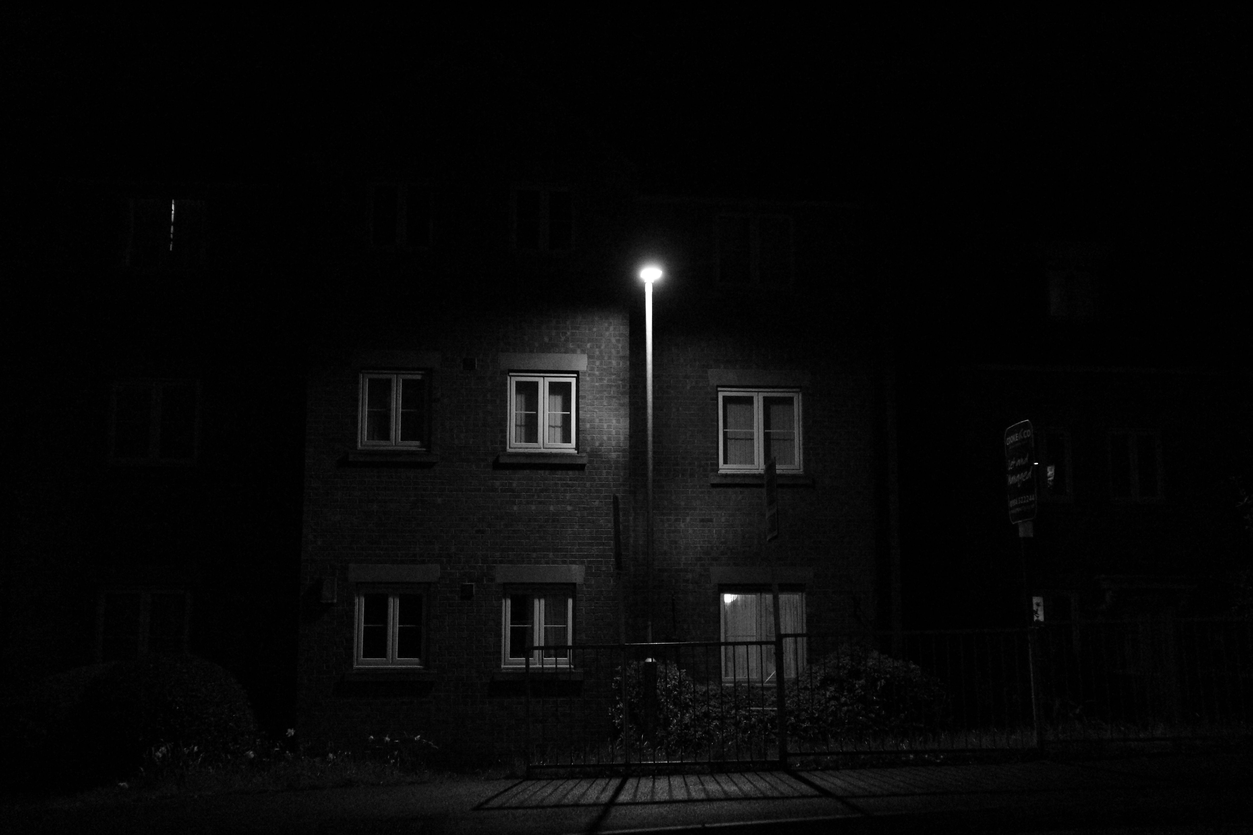 Illuminated Street Light Beside the Concrete Building · Free Stock Photo
