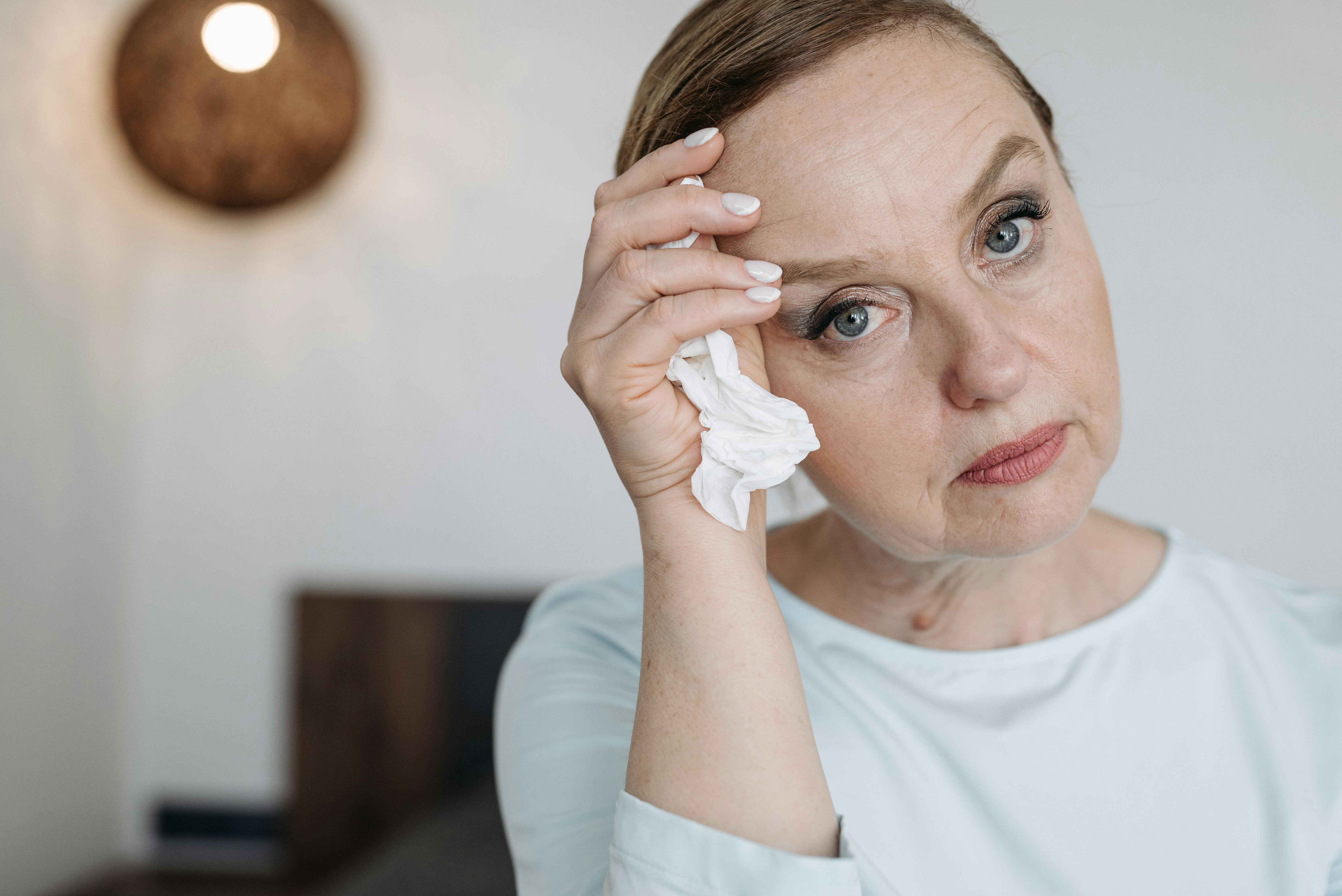 A Woman Holding a Tissue · Free Stock Photo