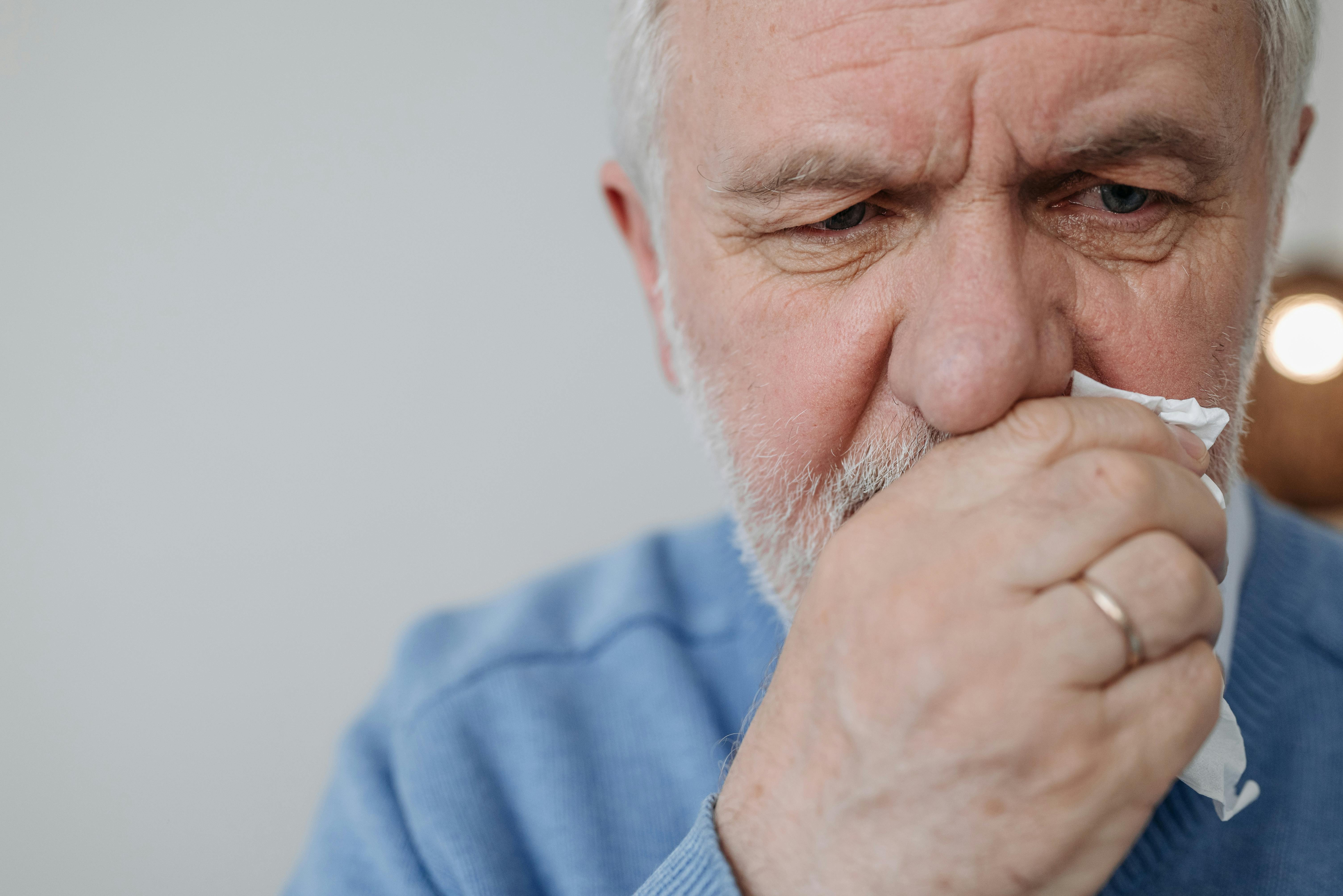A Man Holding a Tissue Paper · Free Stock Photo