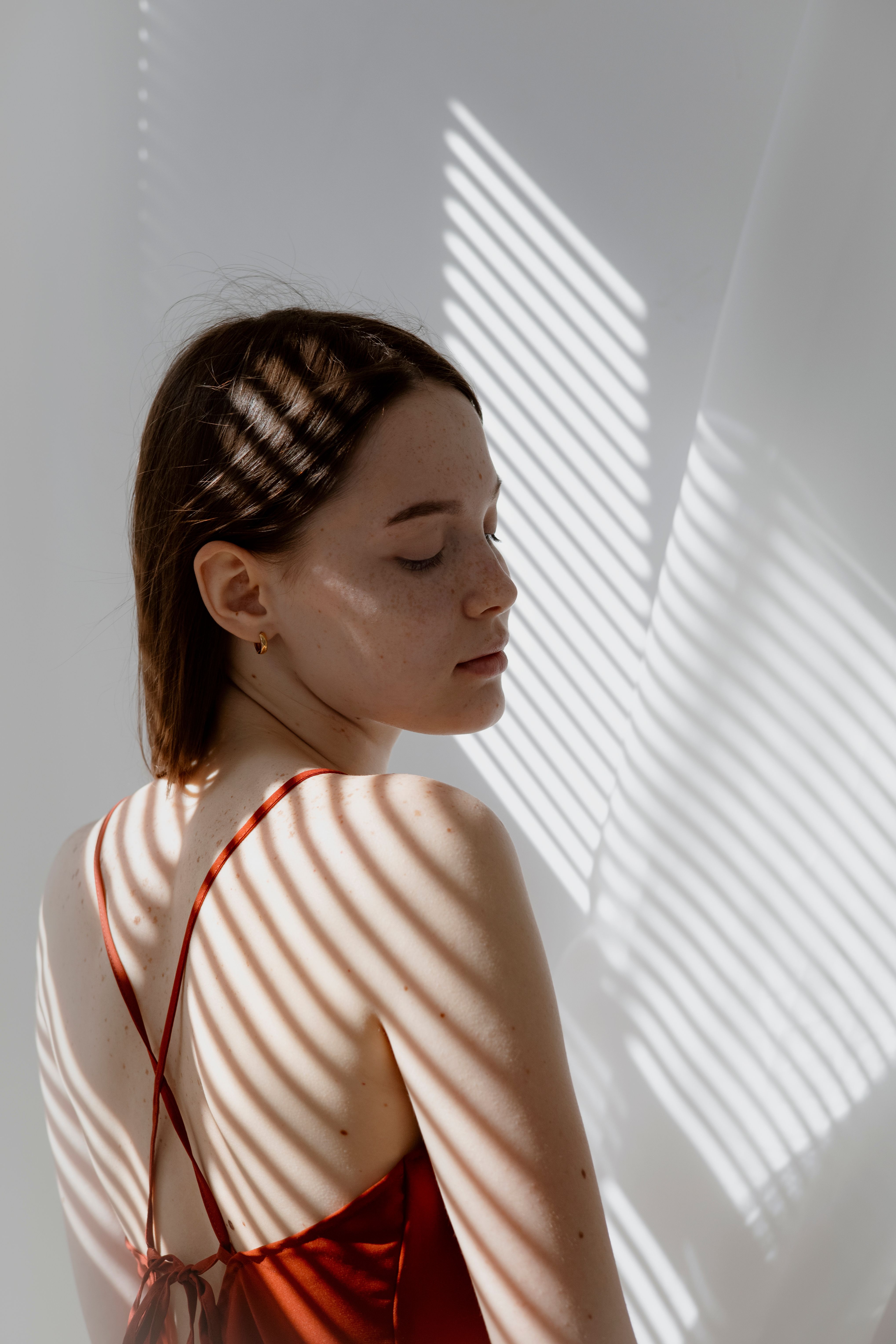 A Woman Wearing a Red Cross Back Strap Dress · Free Stock Photo
