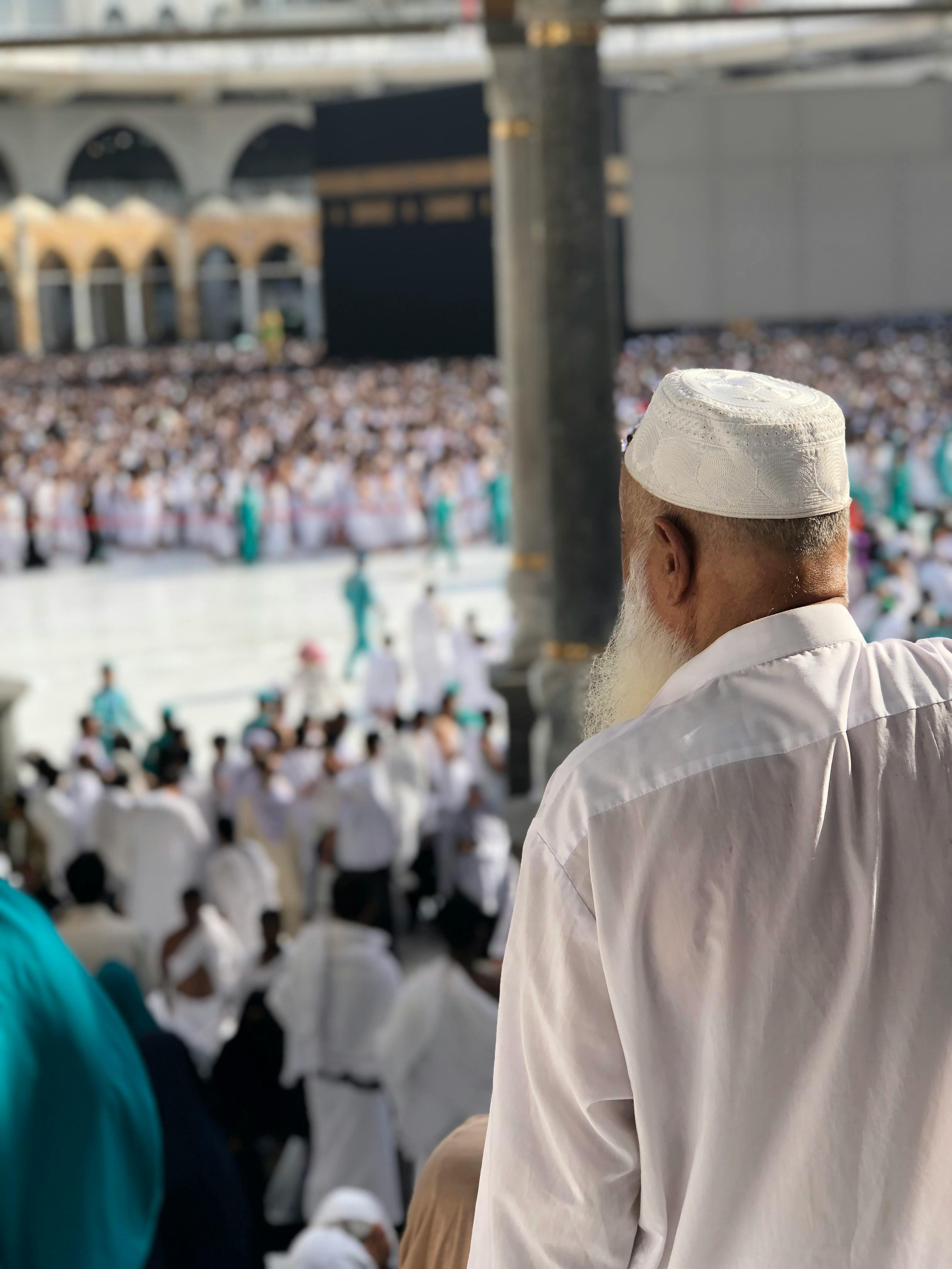 Man Standing In Front of a Crowd Wearing Muslim Prayer Hat · Free Stock ...
