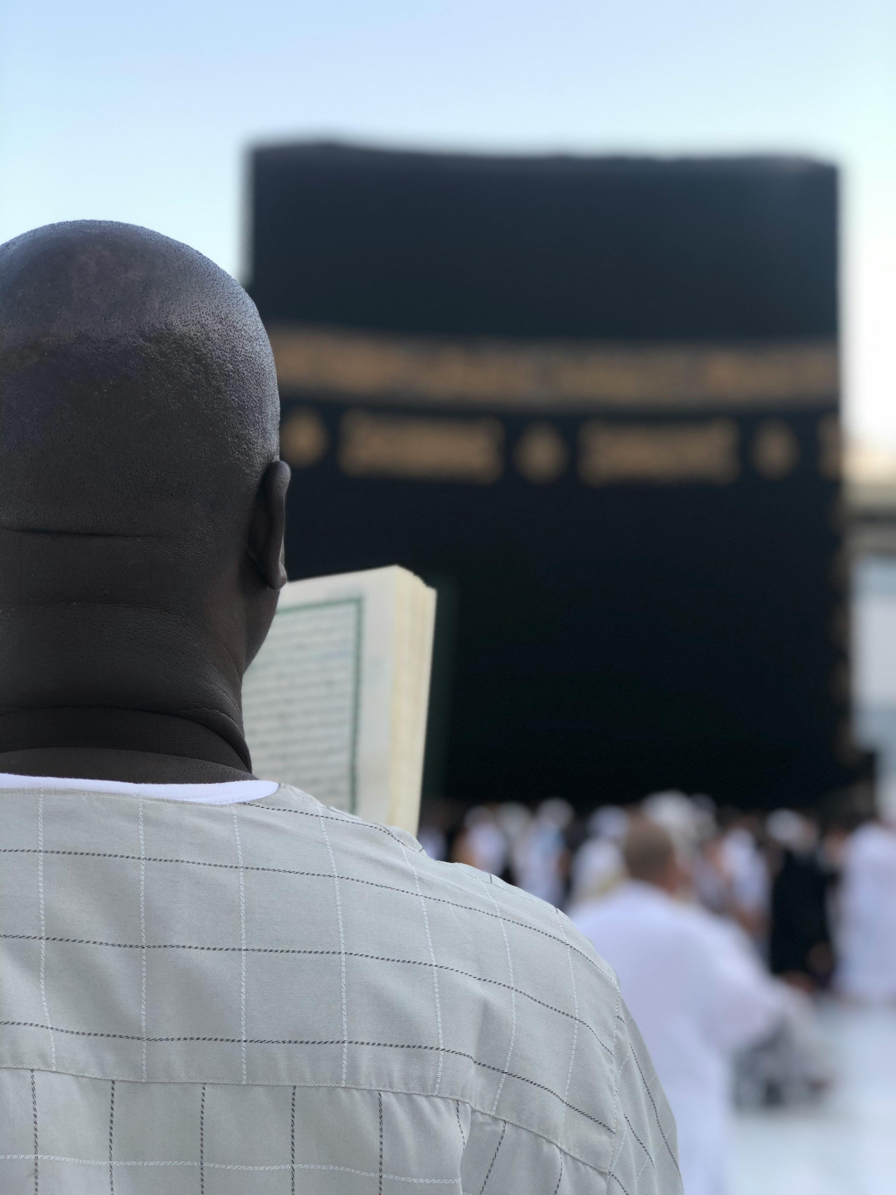 A Person Standing and Praying In Front Of Kaaba · Free Stock Photo