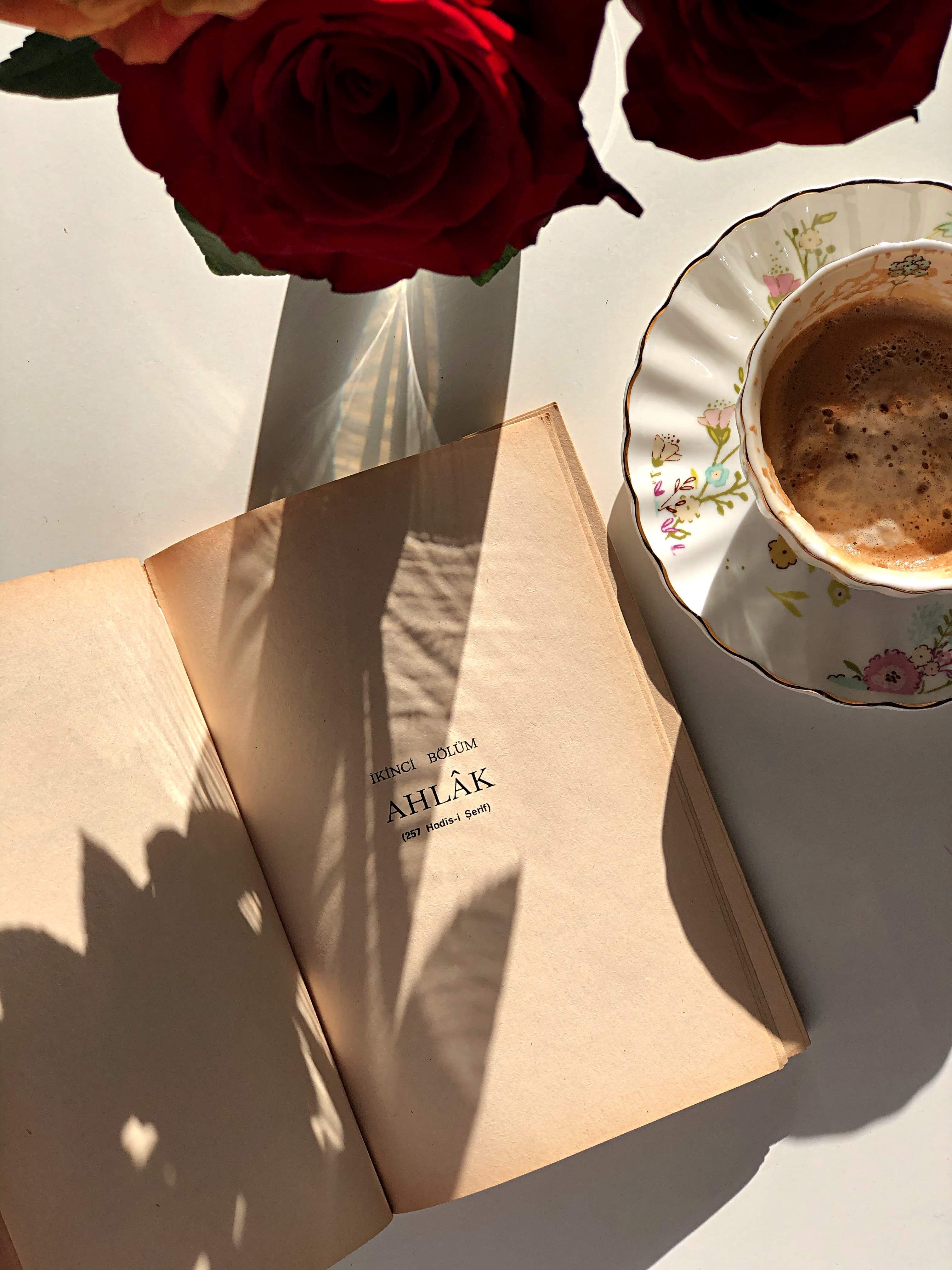 A Cup of Drink and a Book on a Flat Surface · Free Stock Photo