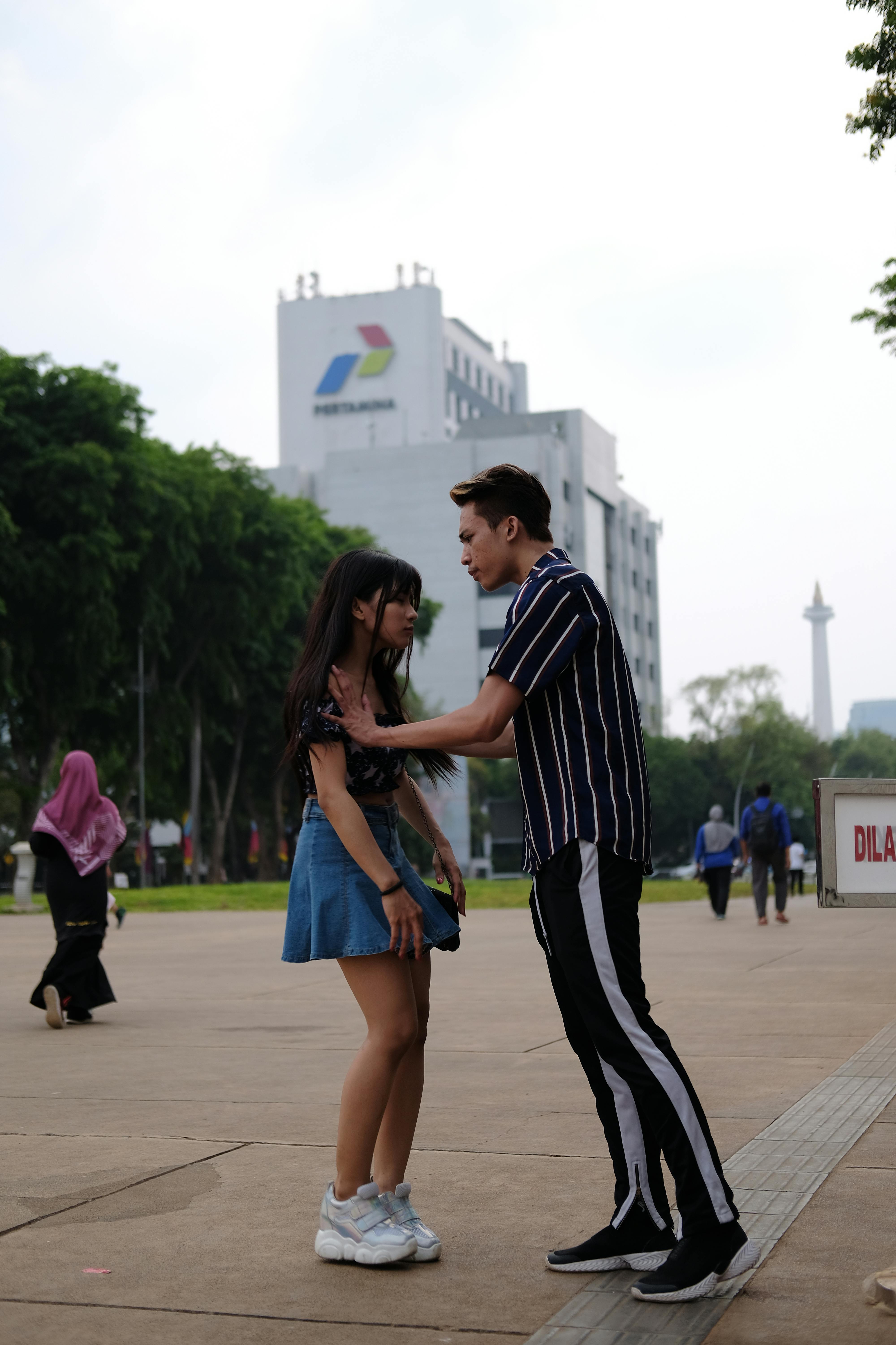 An Upset Boy Pushing Girl on Her Shoulder · Free Stock Photo