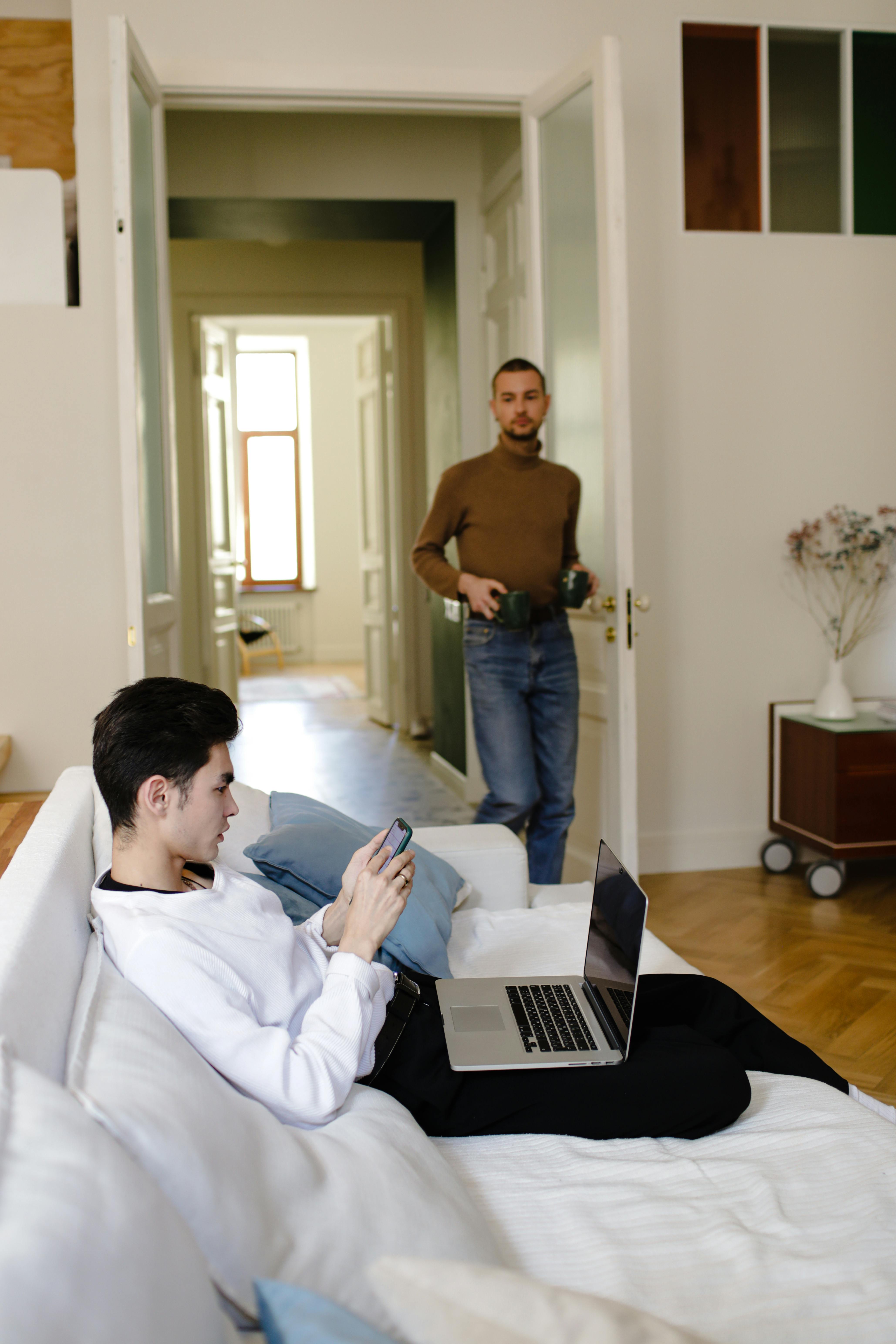 Woman Holds Smartphone Sitting on Chair · Free Stock Photo